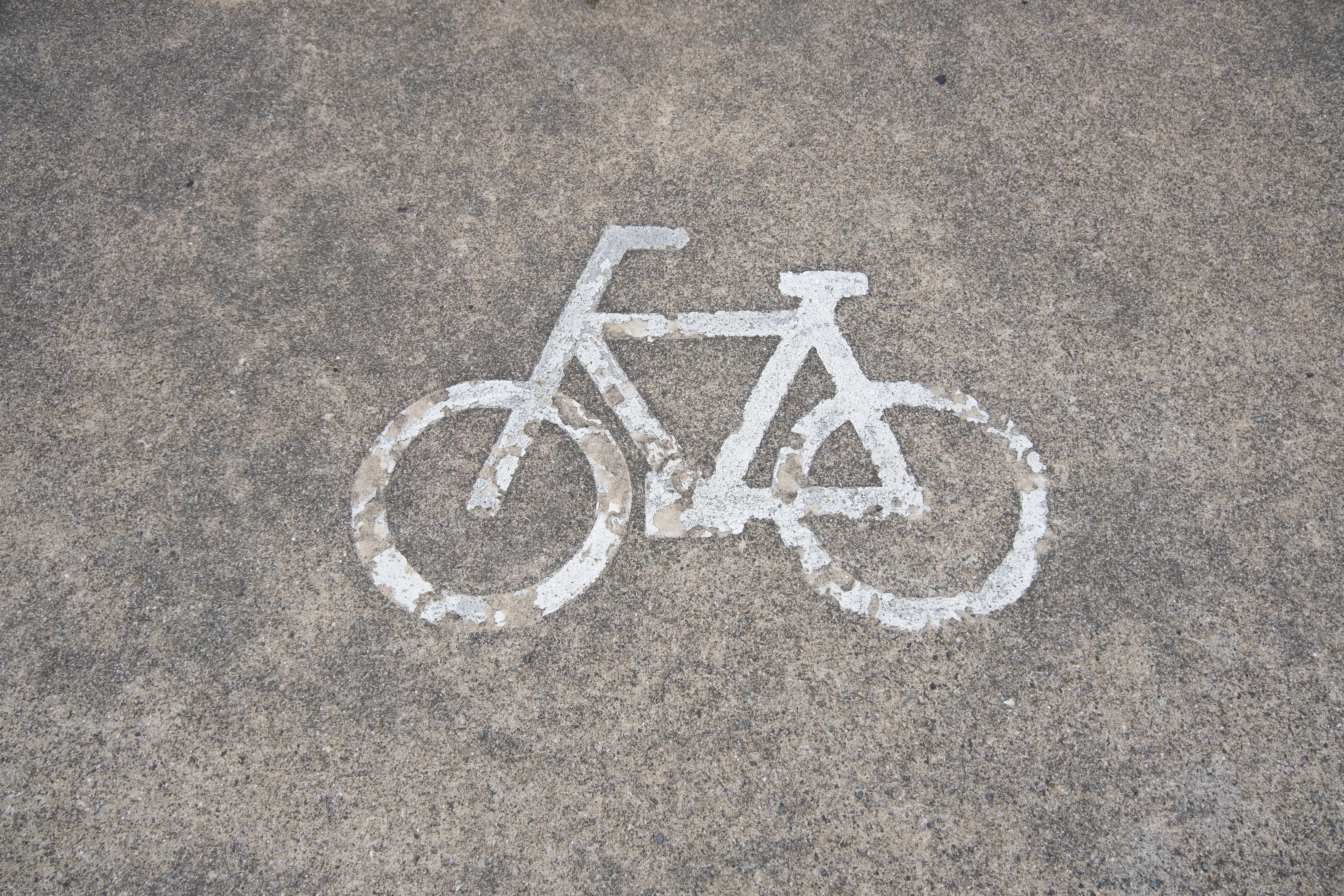 Bicycle Lane on Gray Concrete Road · Free Stock Photo