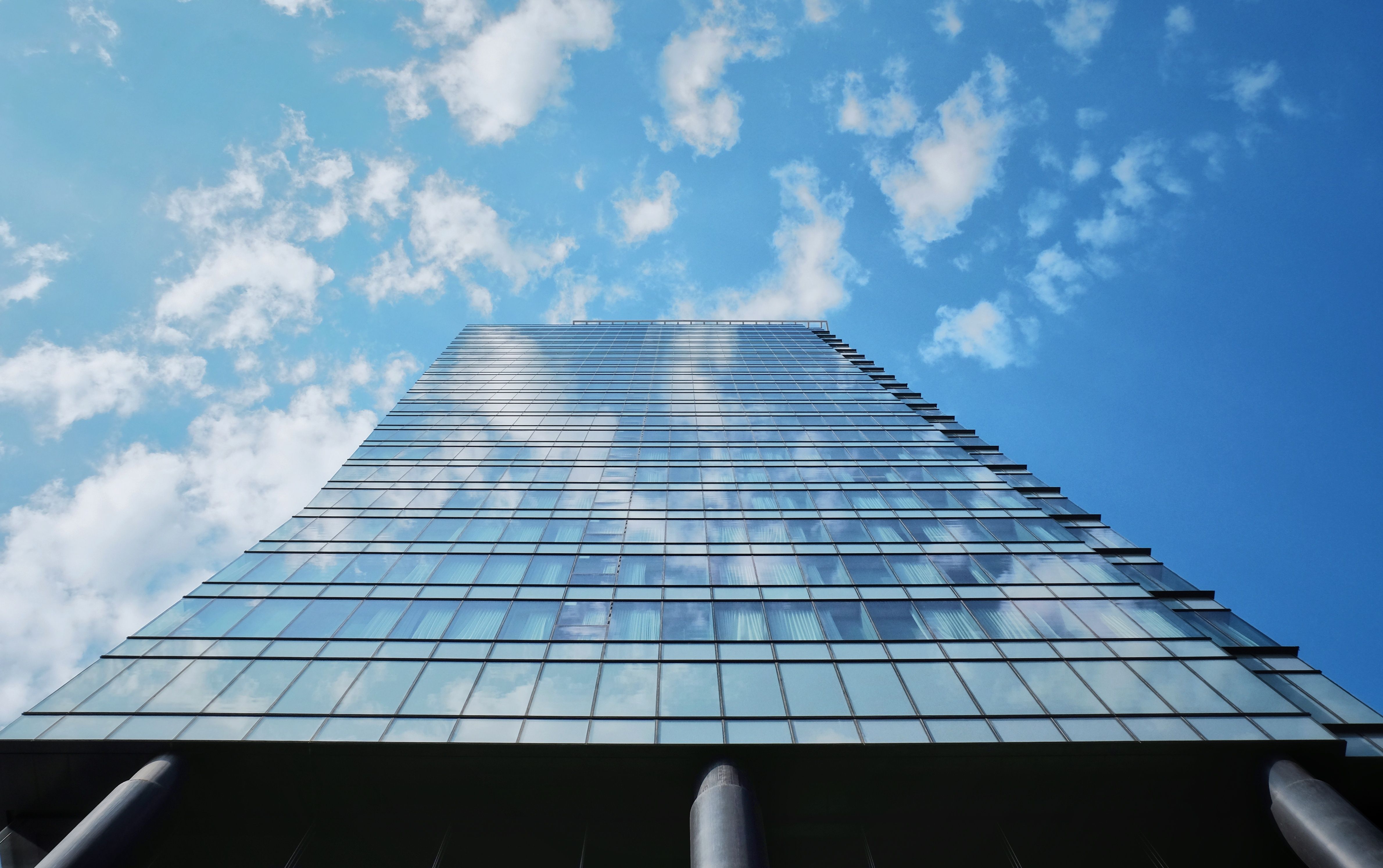 Low Angle Photography of Building Near Tree · Free Stock Photo