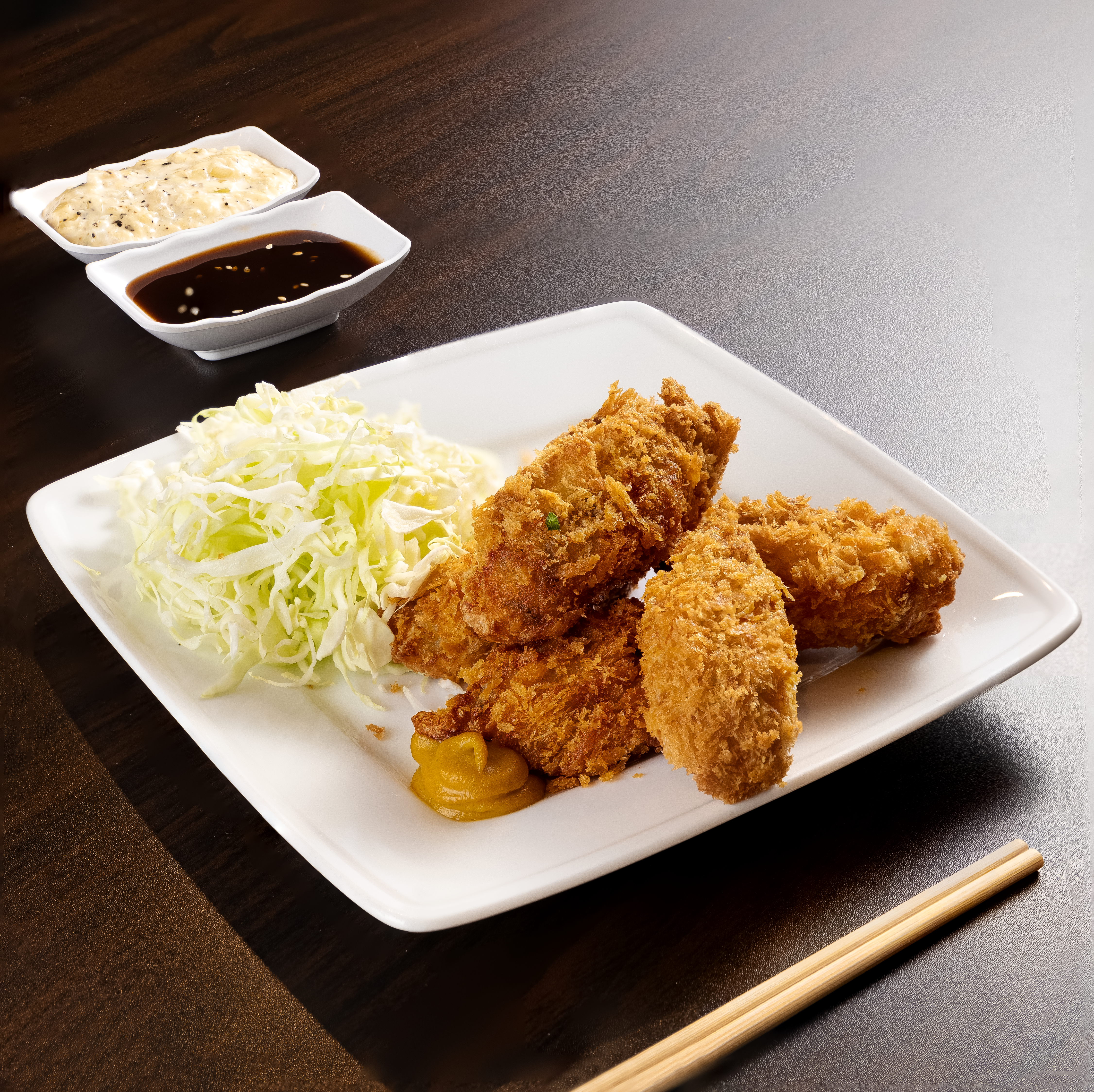 A plate of fried chicken with sauce and chopsticks · Free Stock Photo
