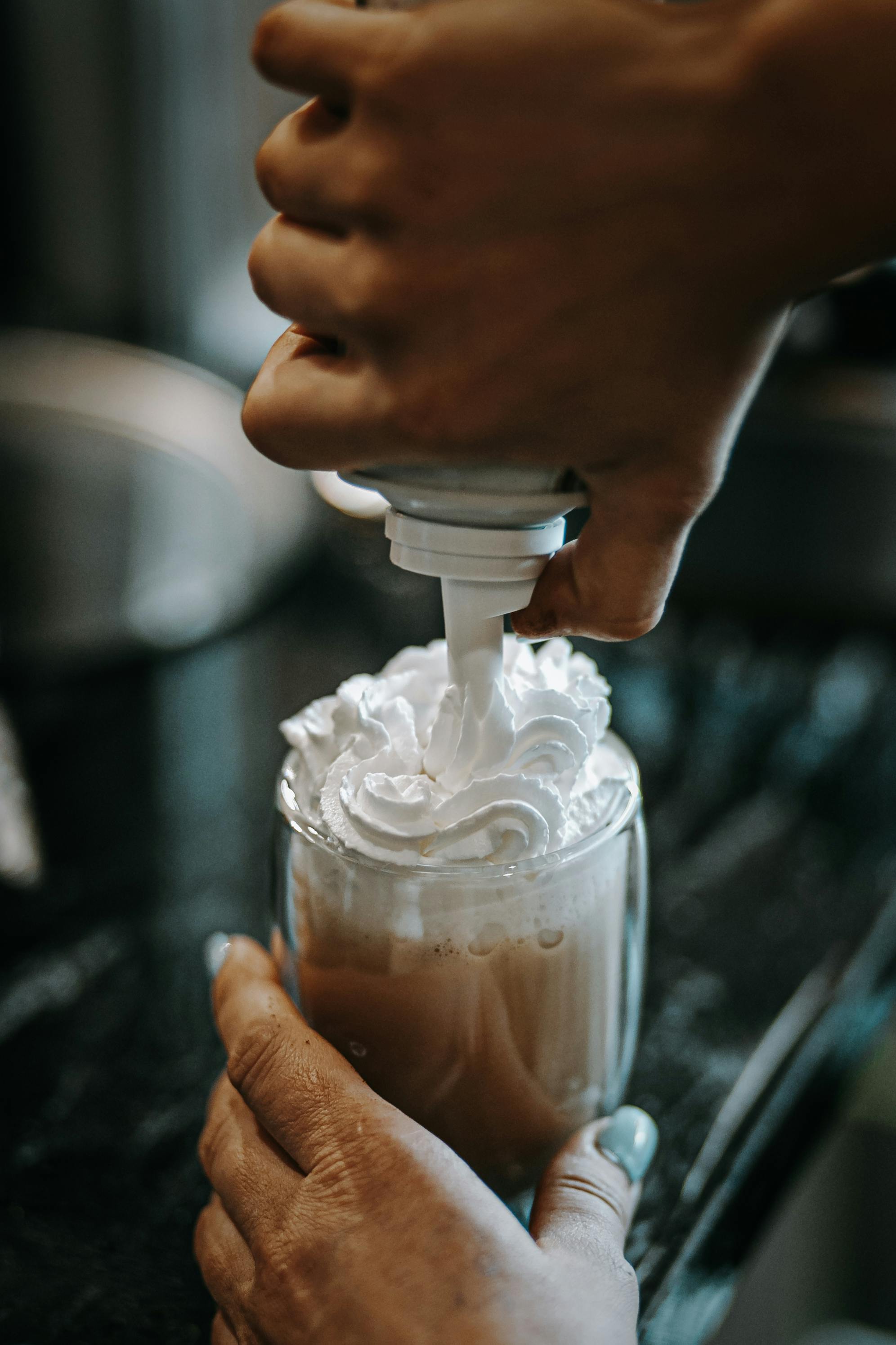 Adding Whipped Cream to Coffee Glass · Free Stock Photo