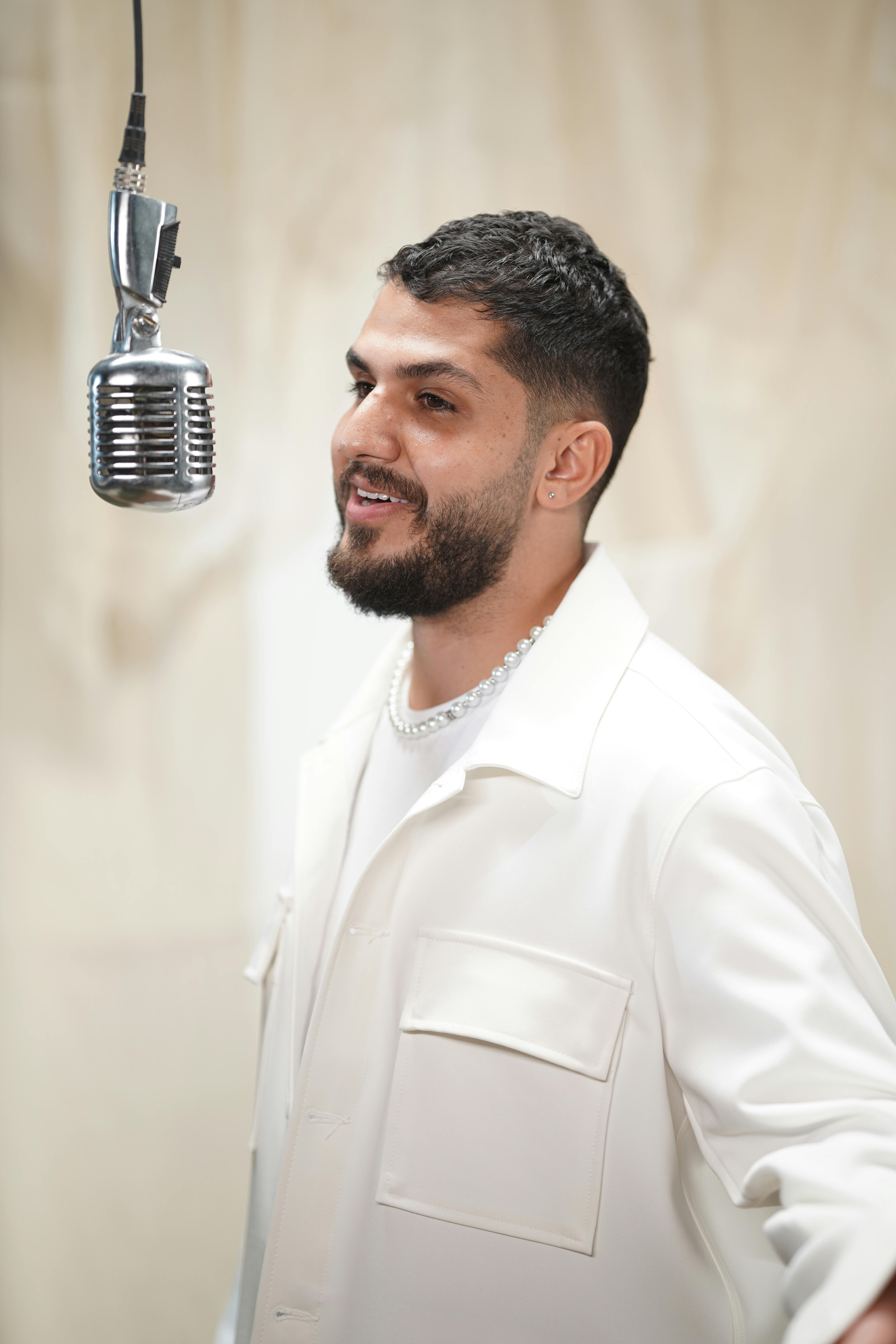 Smiling Singer by Microphone · Free Stock Photo