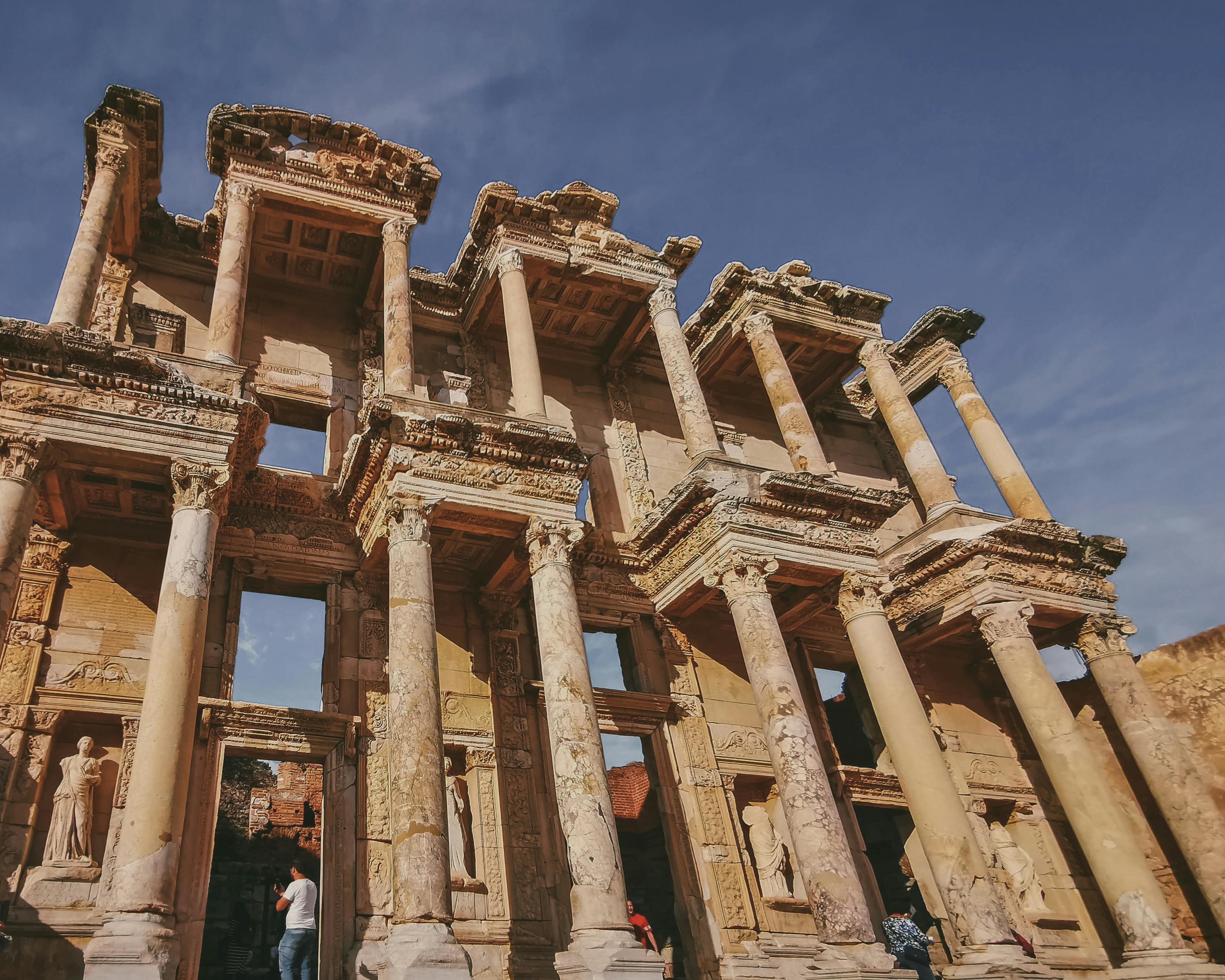 Library of Celsus with sculpture and damaged wall · Free Stock Photo