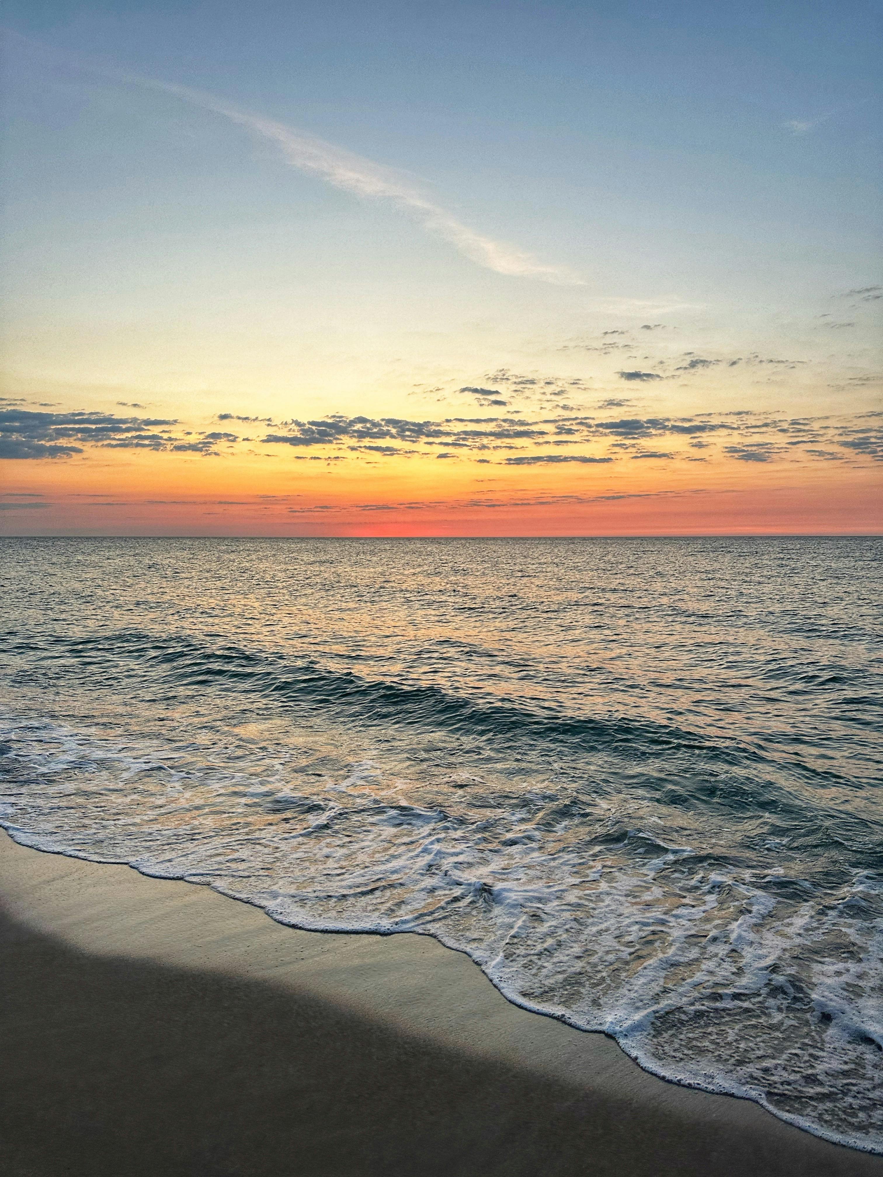Photo of Person Walking on Beach Shore · Free Stock Photo