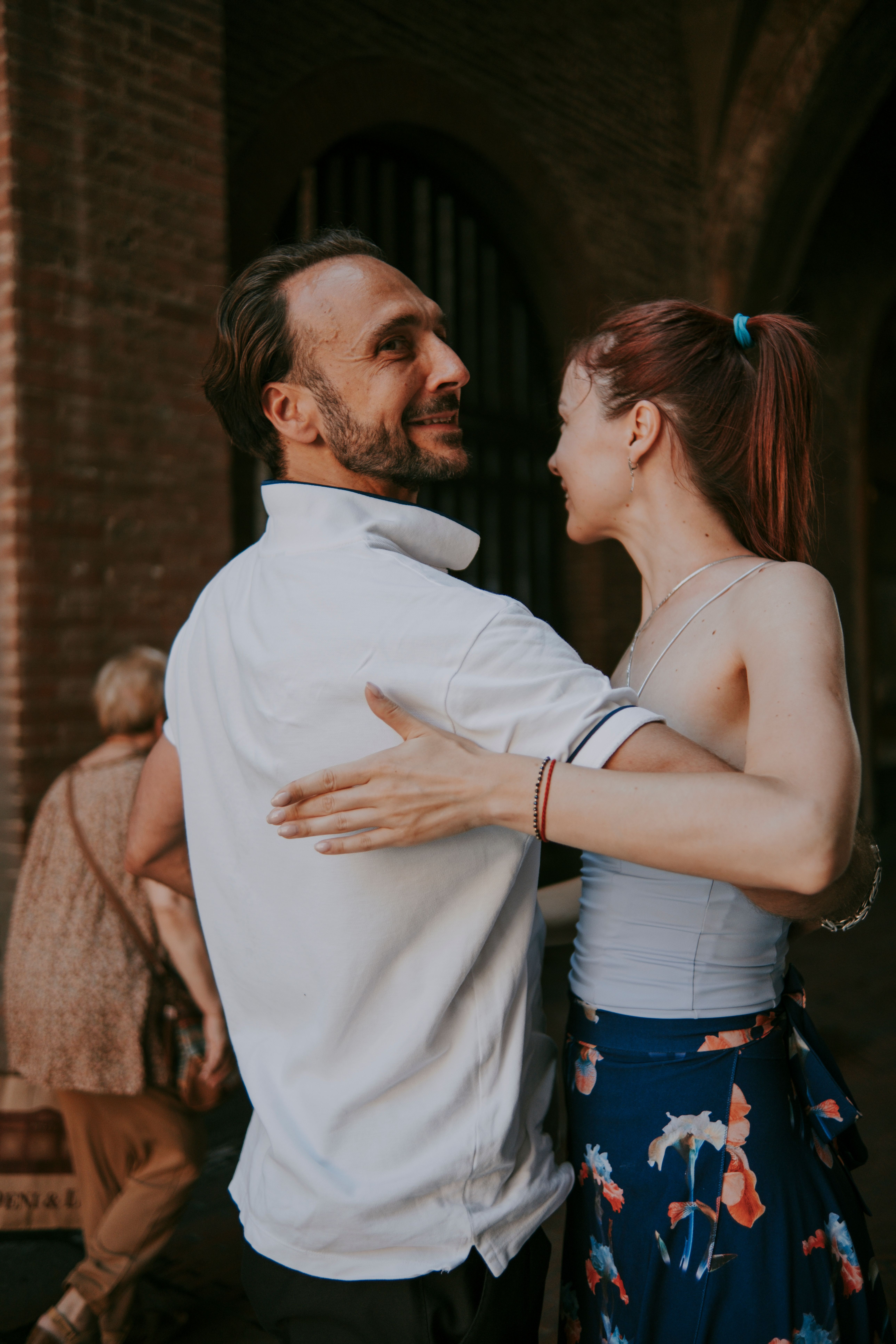 Smiling Couple Embracing and Dancing · Free Stock Photo