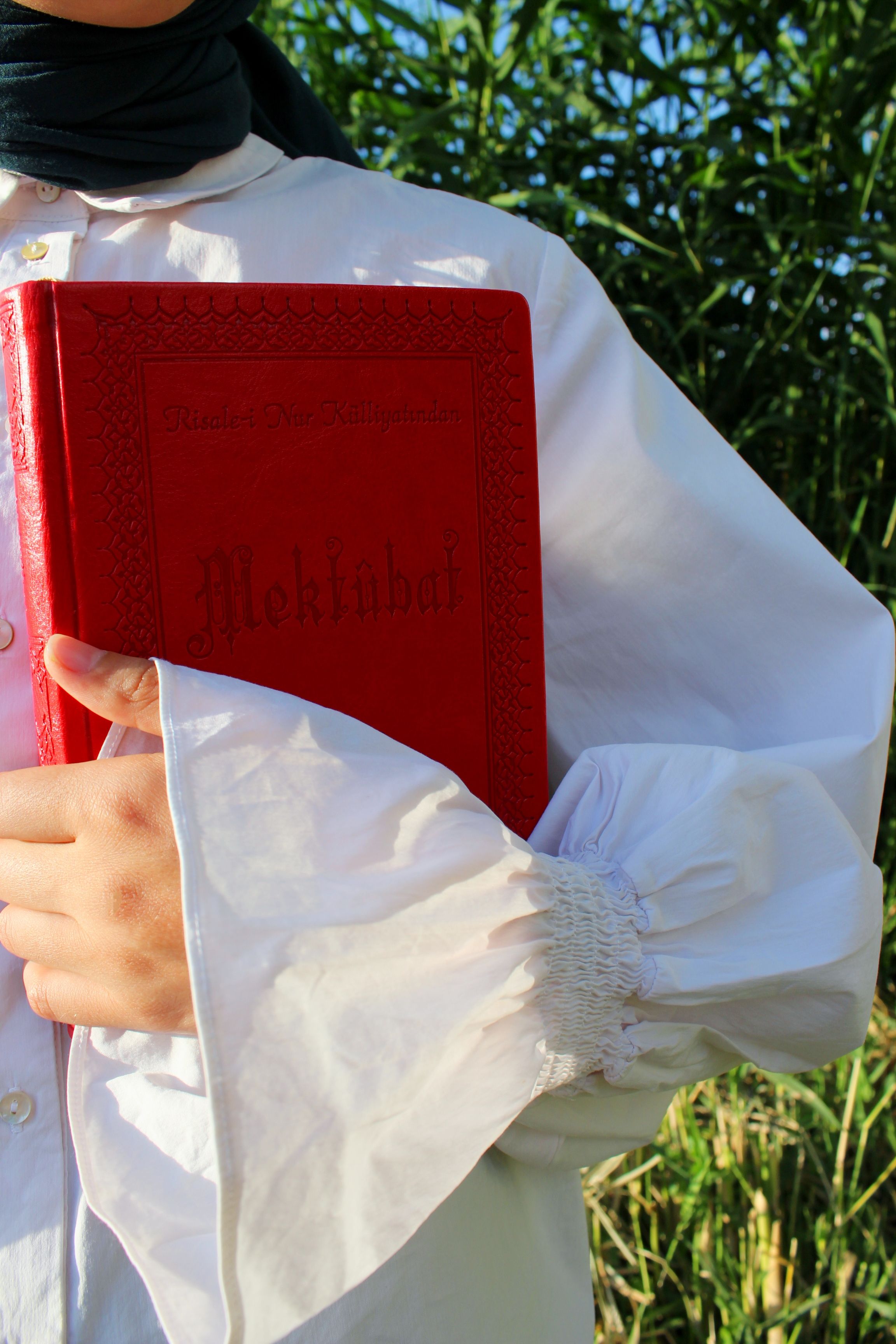 Hand on Book near Bag · Free Stock Photo