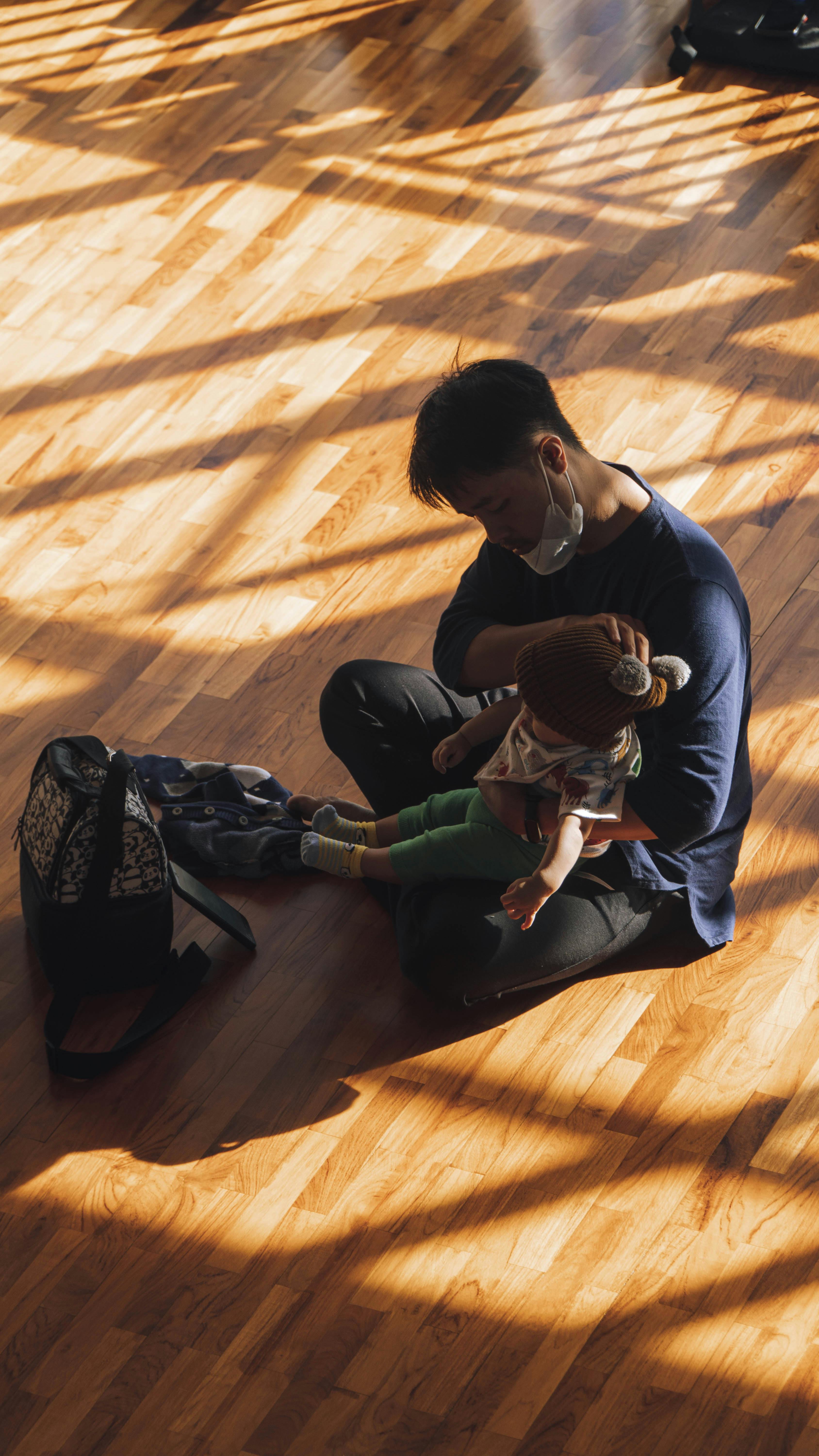 Father Sitting with Baby on Floor · Free Stock Photo