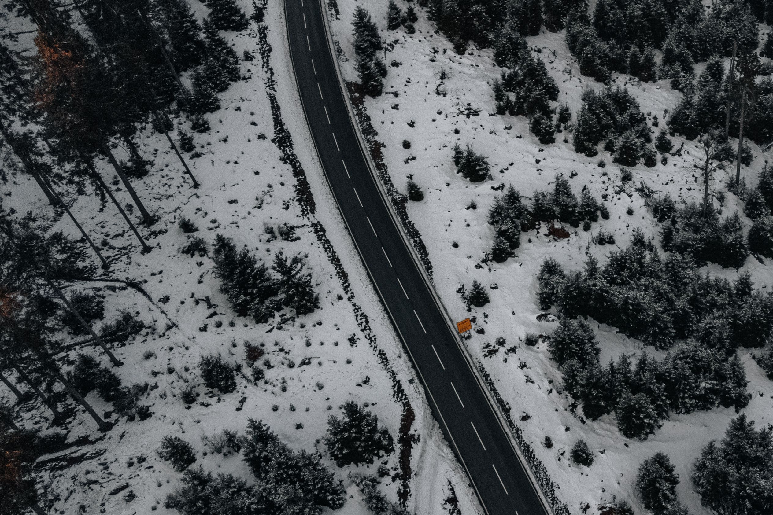 Aerial View of an Asphalt Road Stretching through a Snow-Covered ...