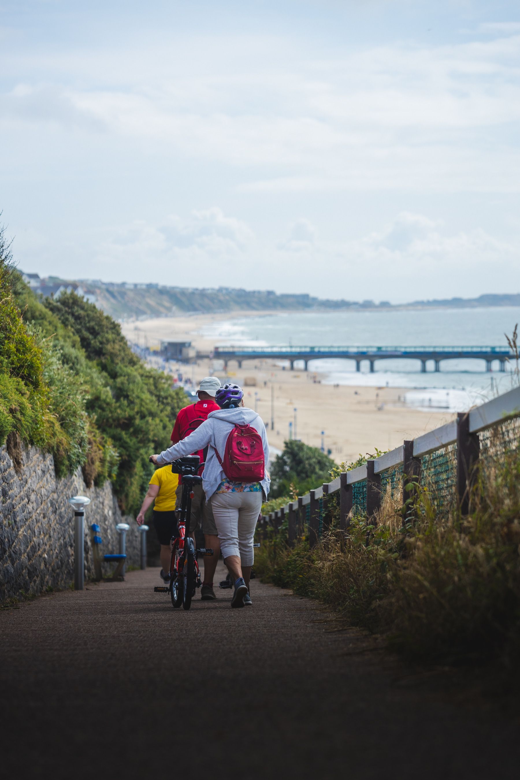 People on a Slope Leading to a Sandy Beach · Free Stock Photo