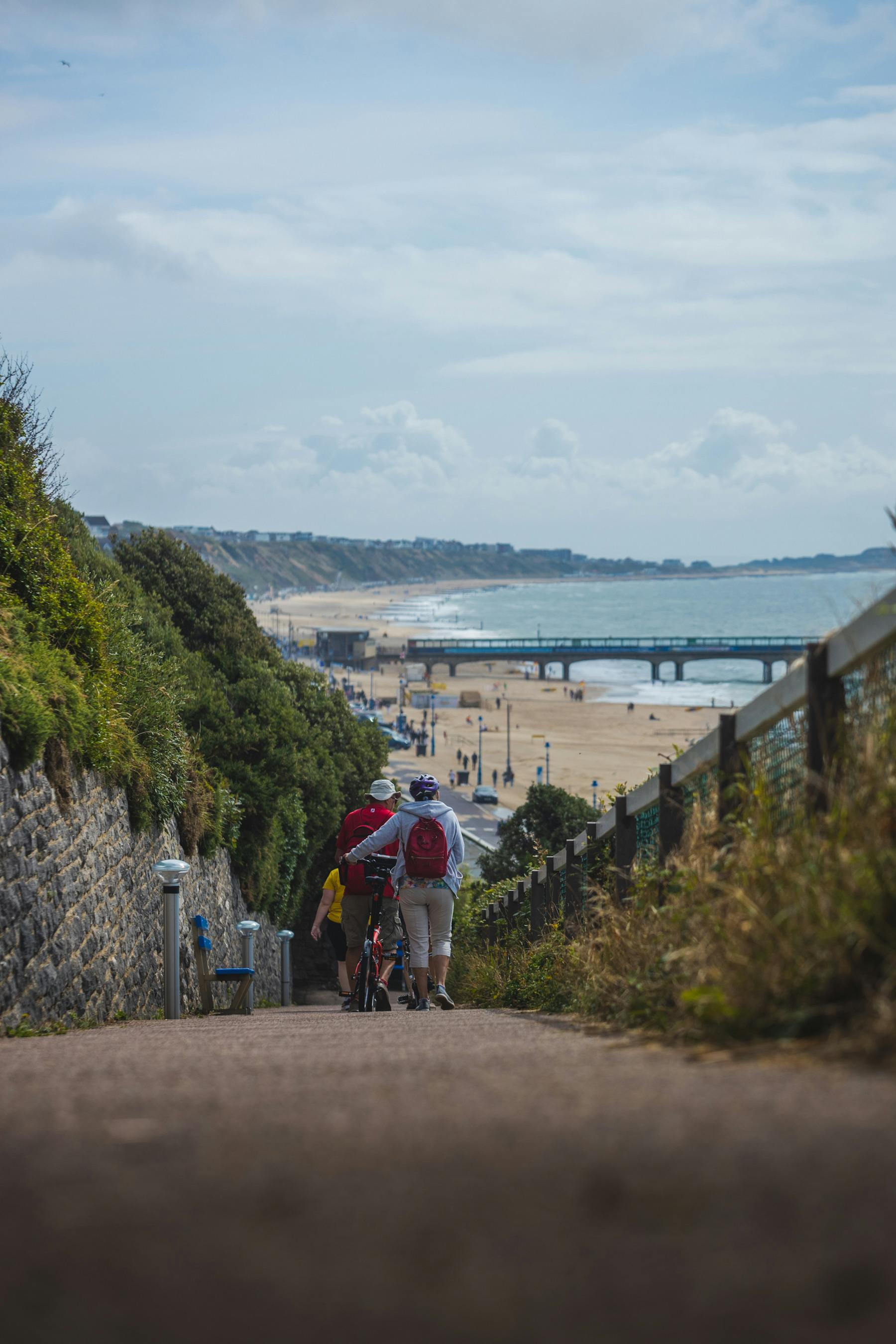 People Walking along a Sloped Footpath Leading to a Beach · Free Stock ...