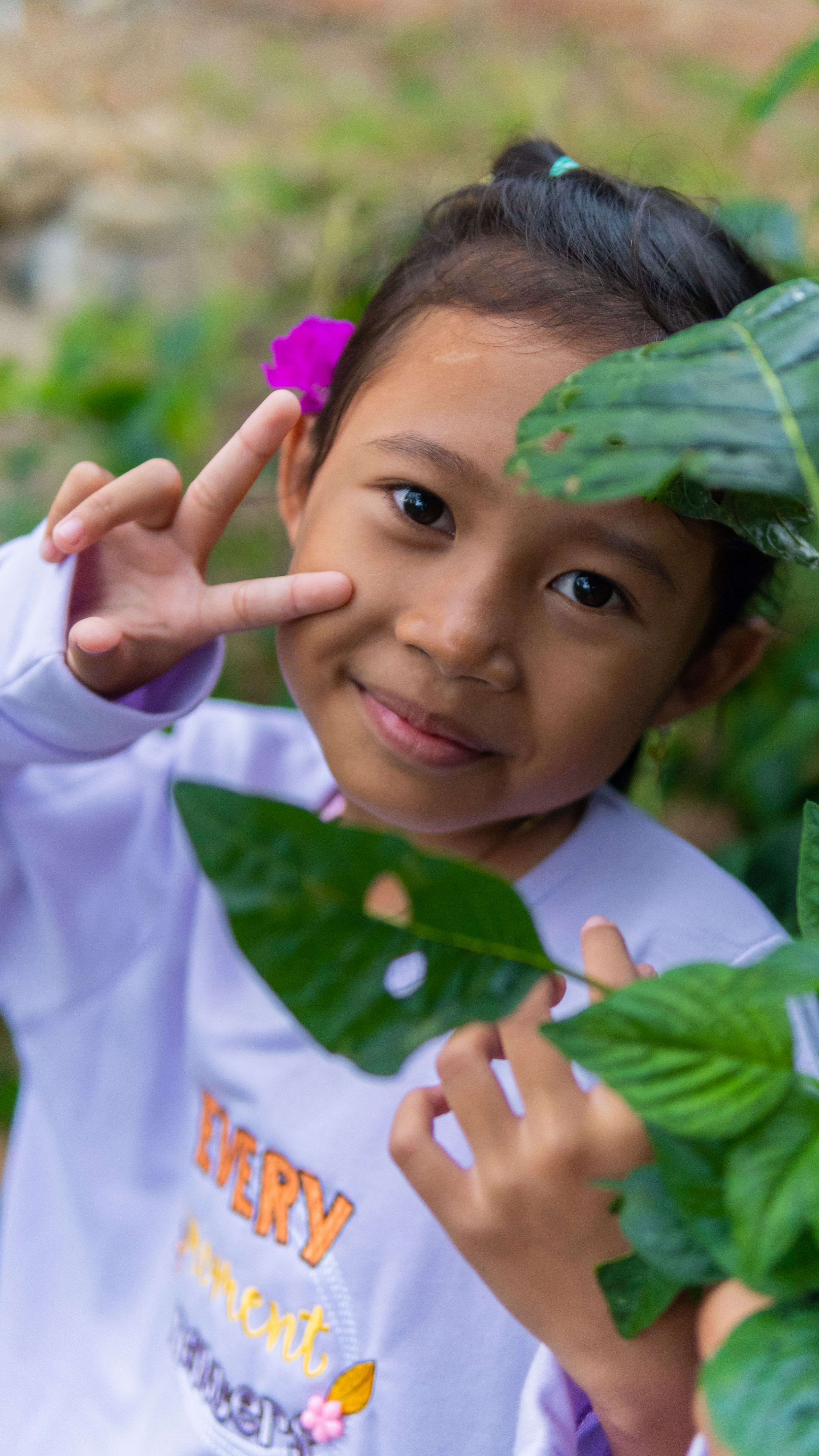 Smiling Girl Showing Peace Gesture · Free Stock Photo