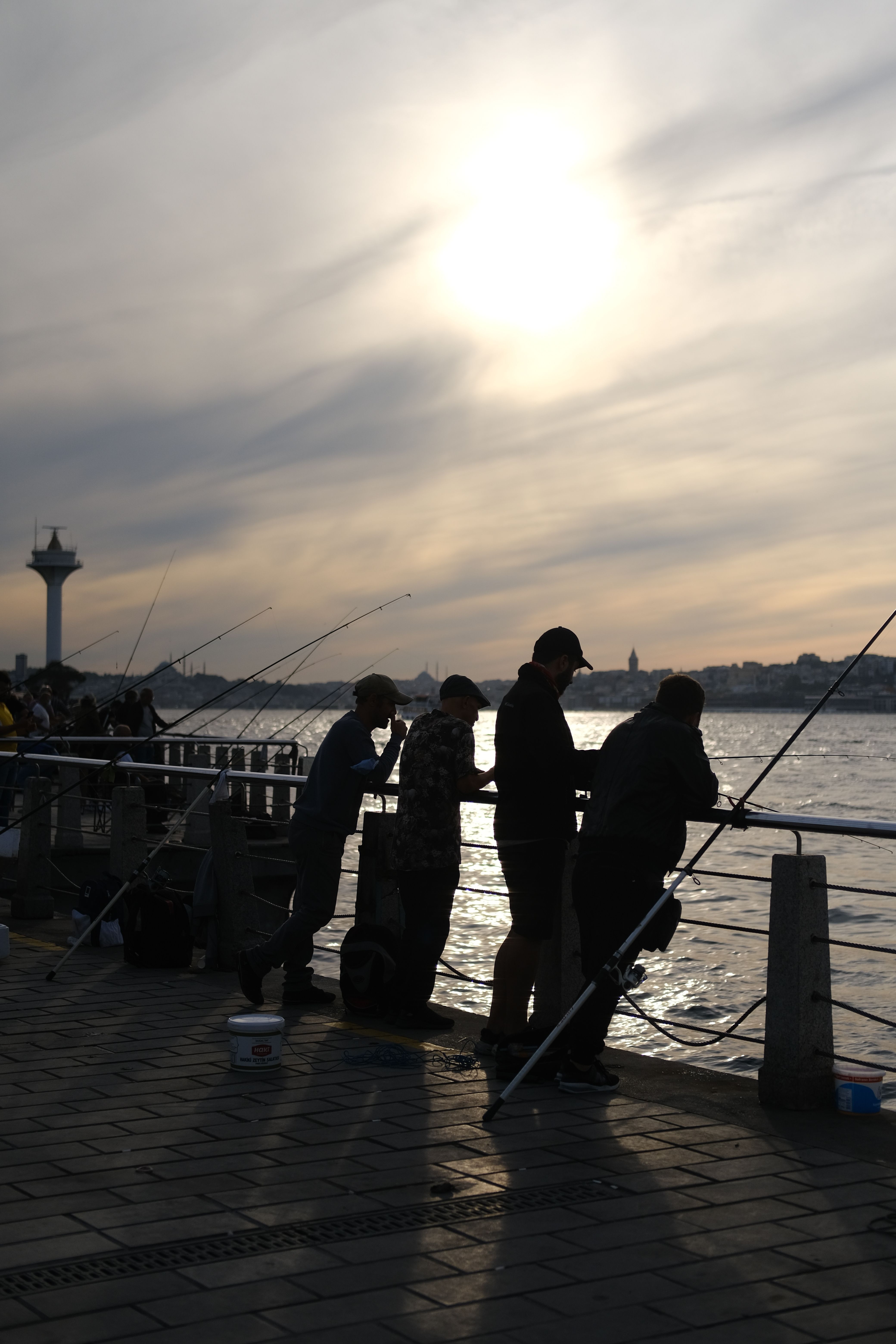People fishing at the pier at sunset · Free Stock Photo