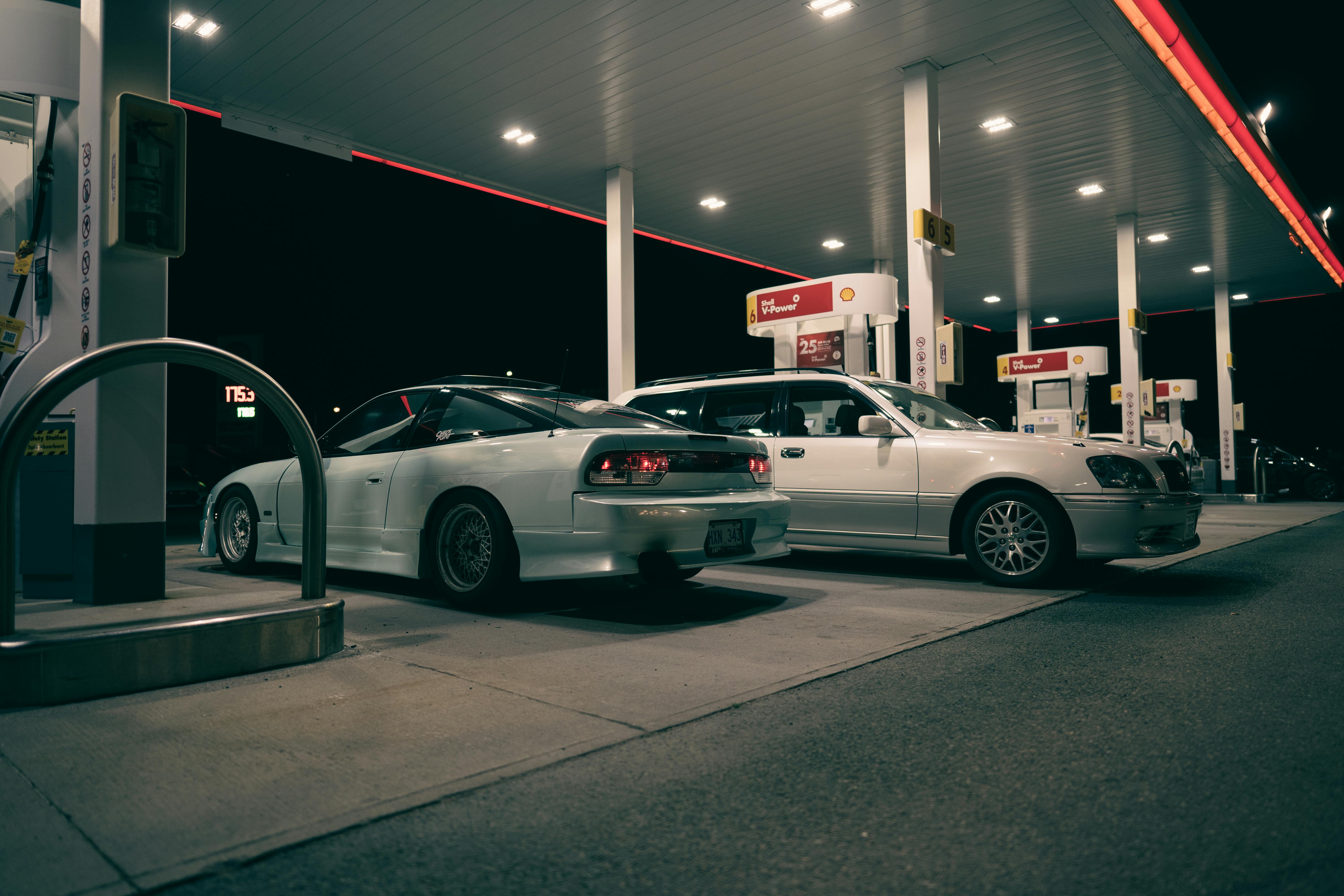 Two cars parked at a gas station at night · Free Stock Photo