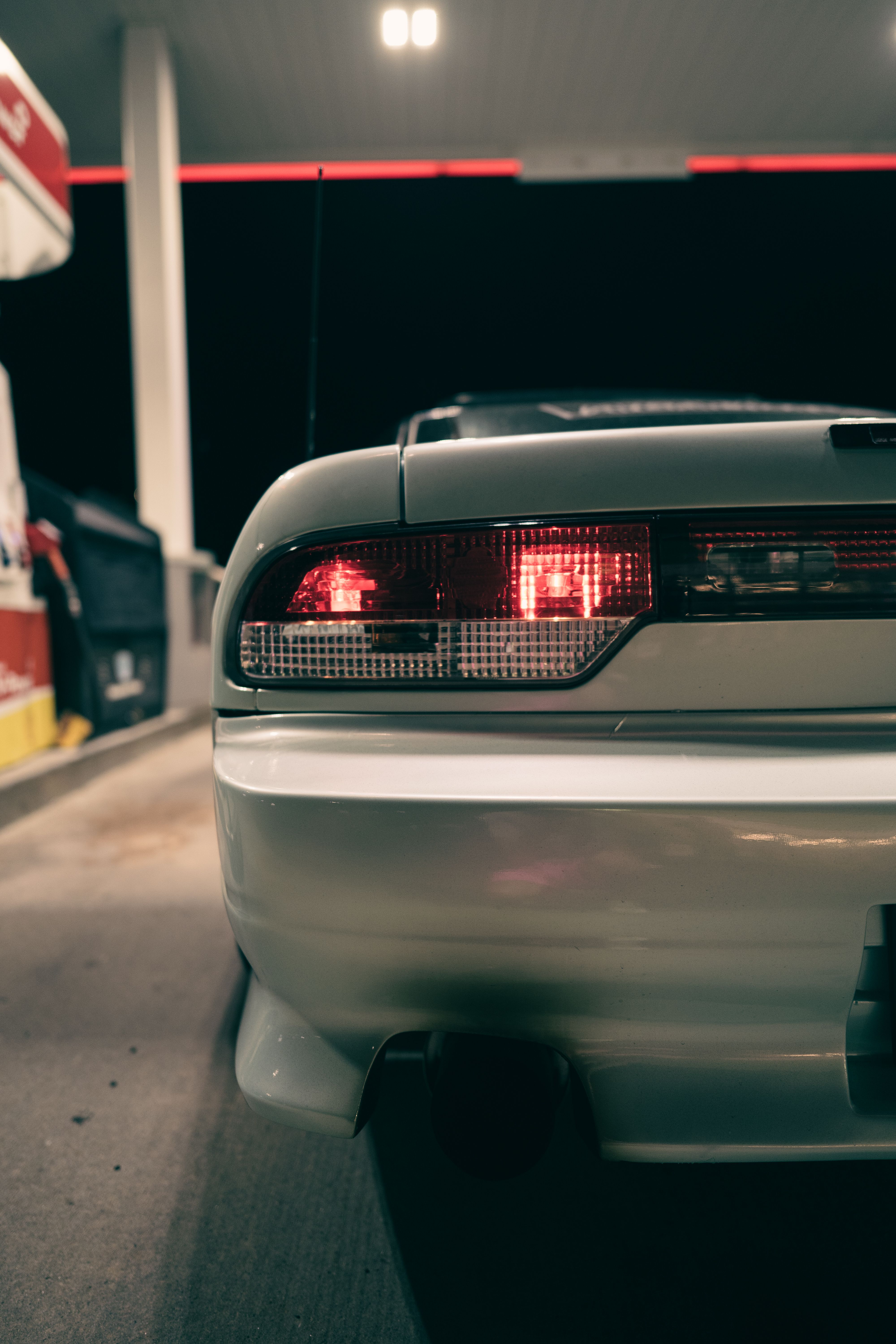 A white car is parked at a gas station · Free Stock Photo