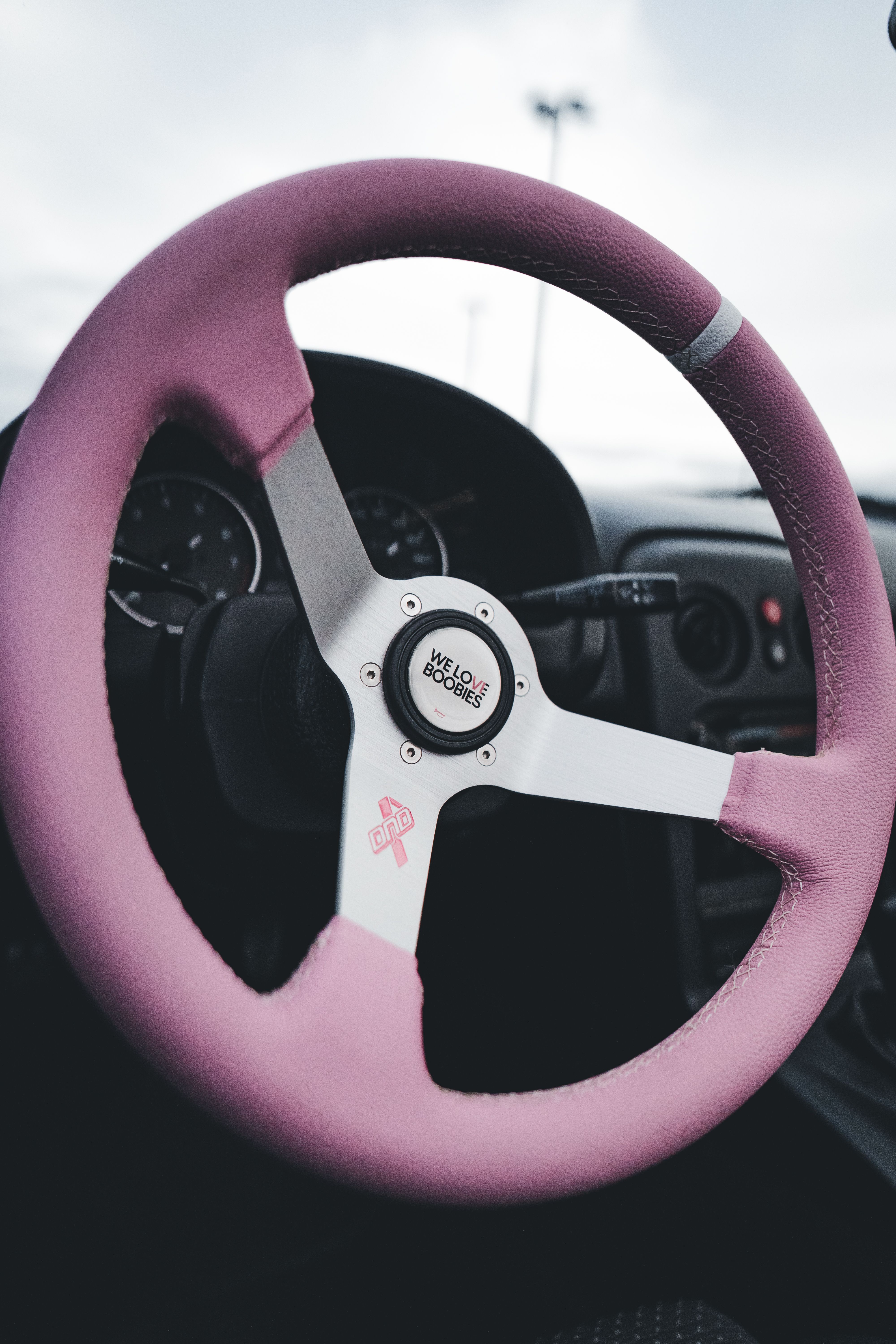 A steering wheel with pink and silver trim · Free Stock Photo