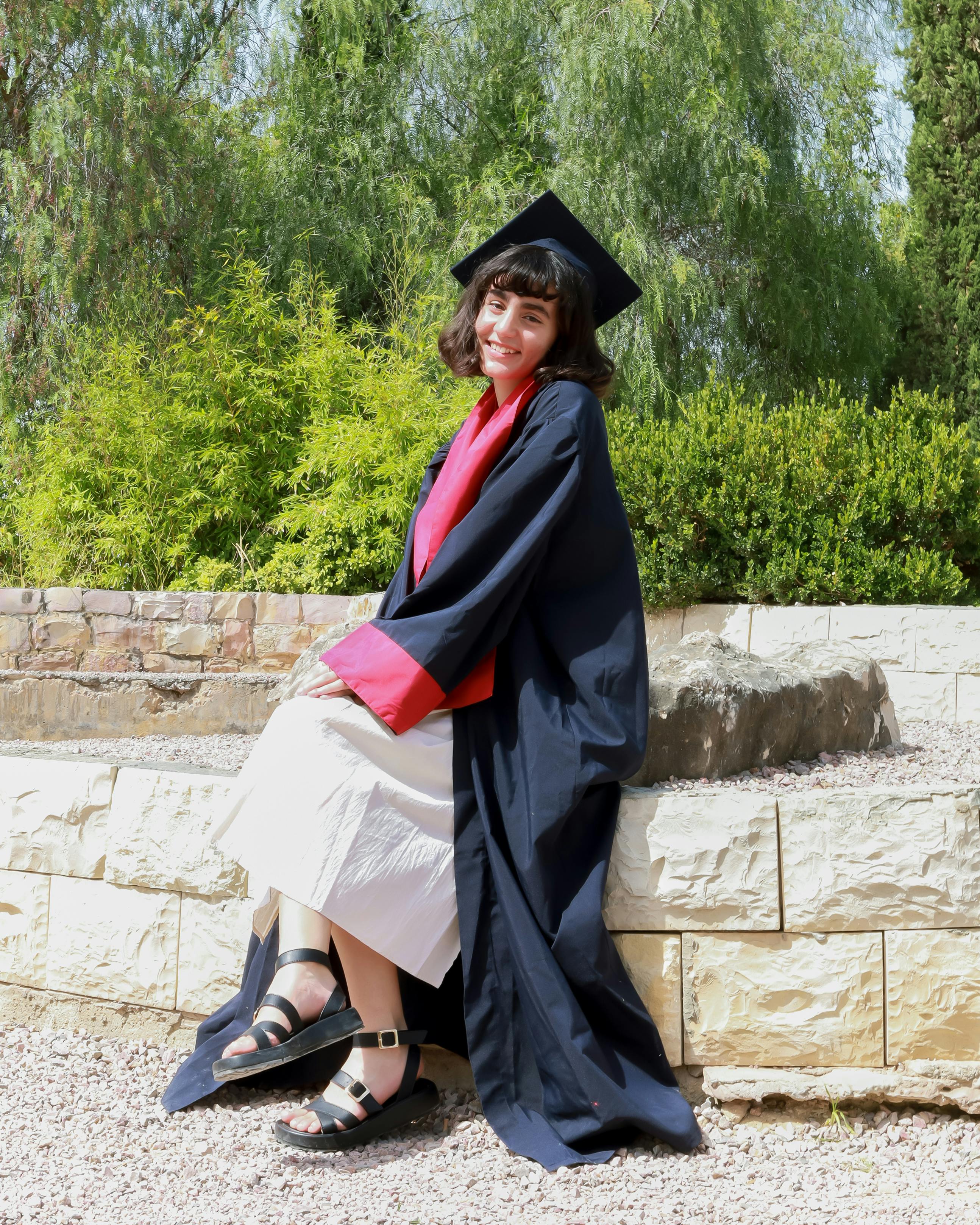 Smiling Graduate Sitting at Park · Free Stock Photo