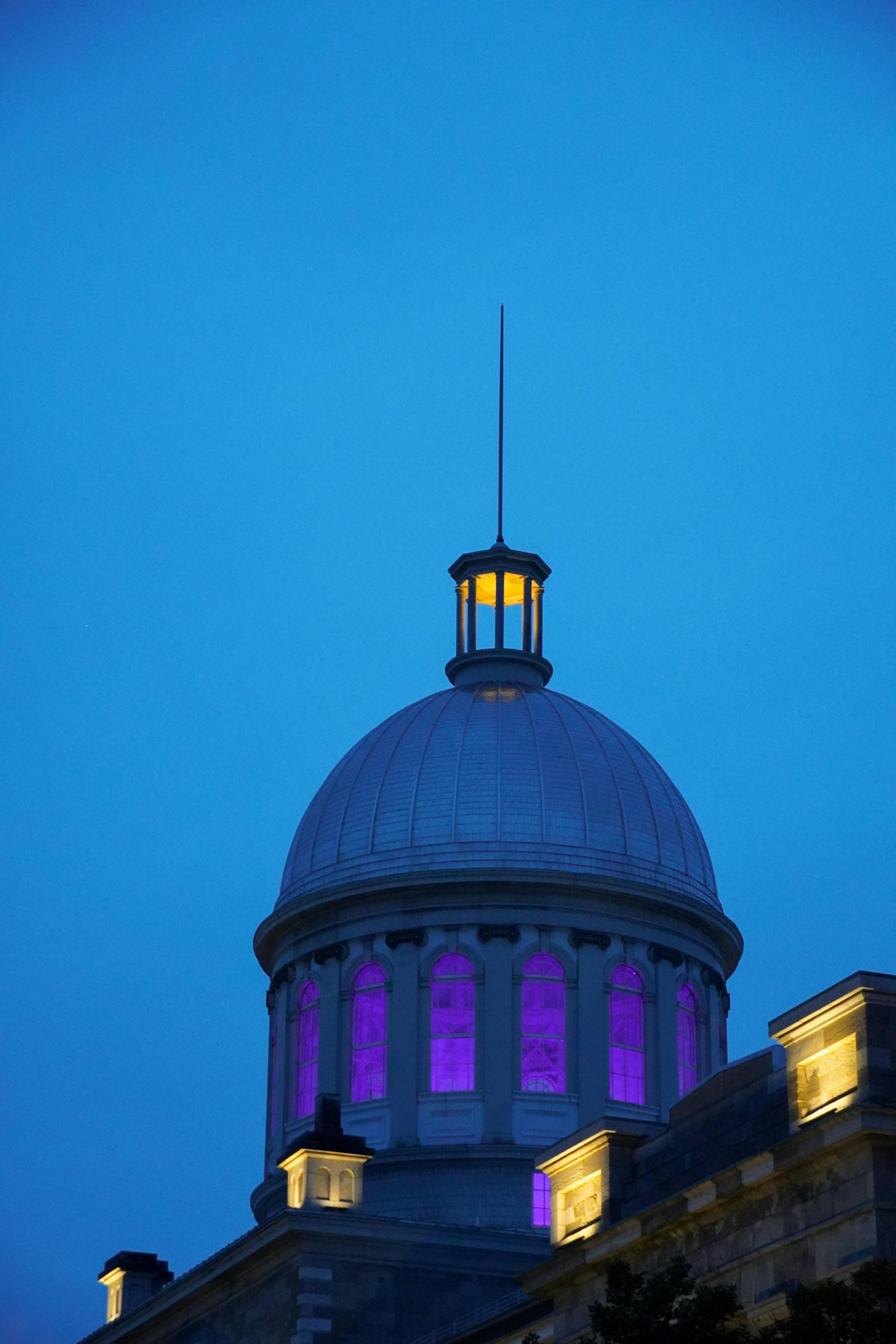 The dome of the state capitol building is lit up purple · Free Stock Photo
