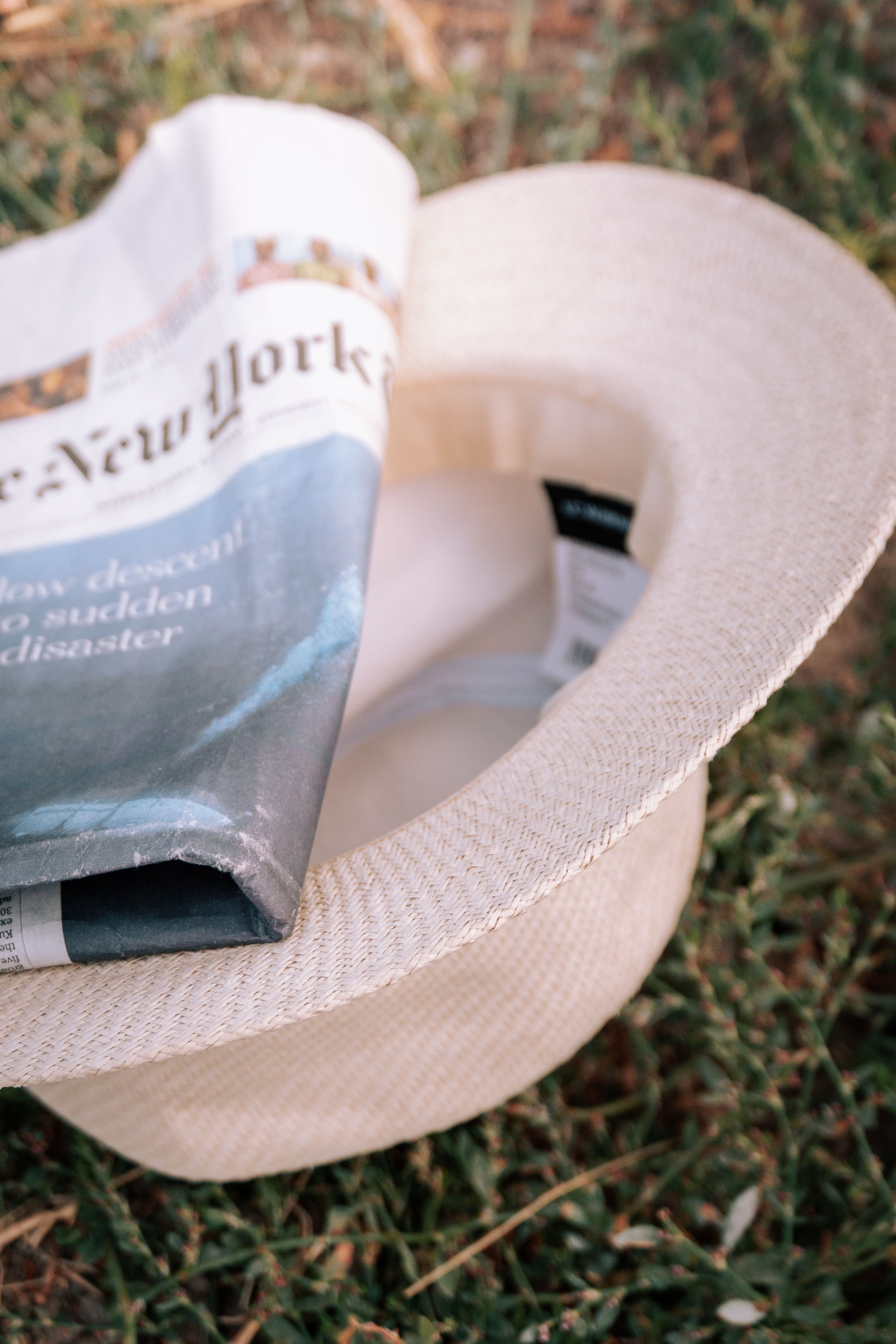 A hat and newspaper on the grass · Free Stock Photo