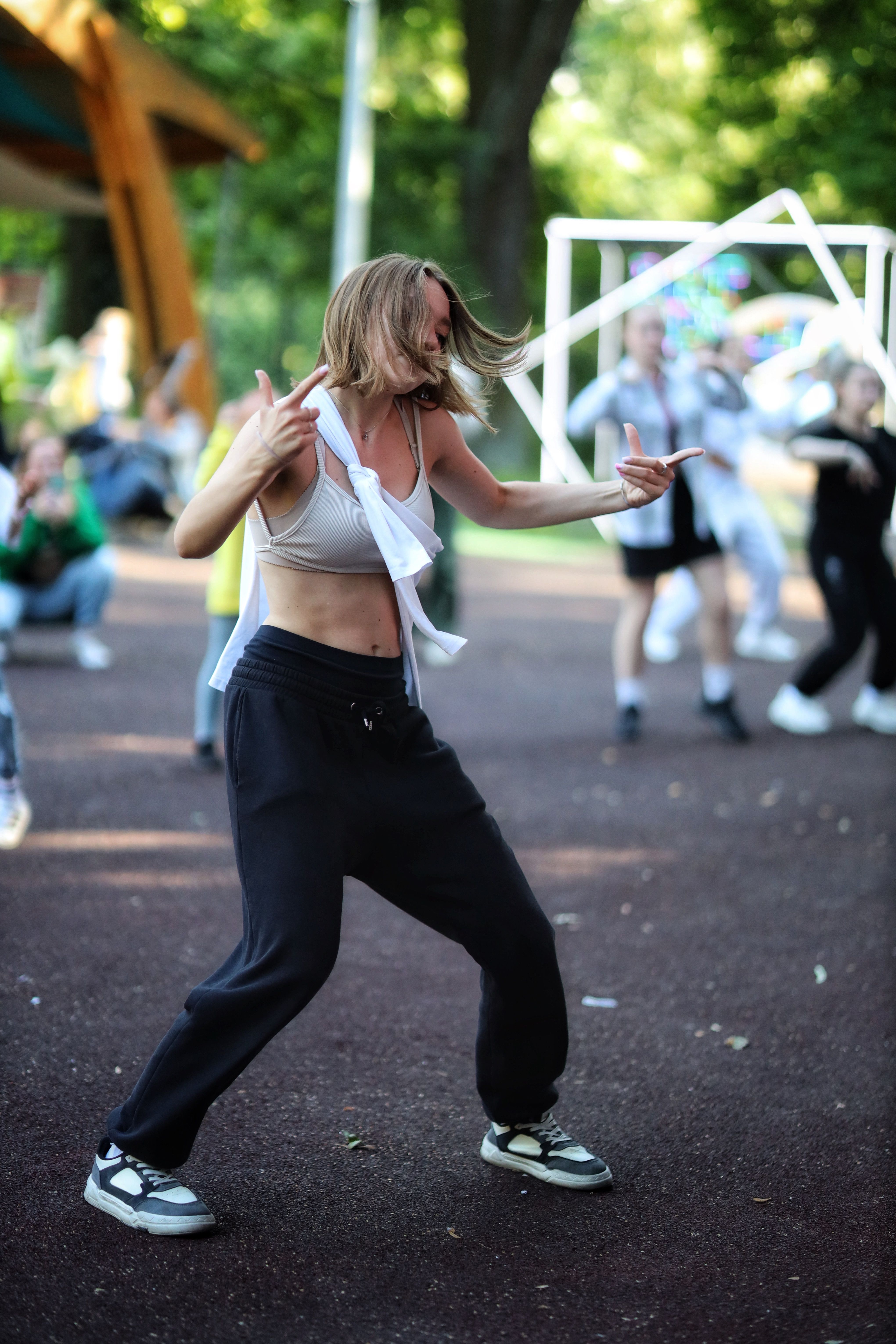 A woman in a white top and black pants dancing · Free Stock Photo