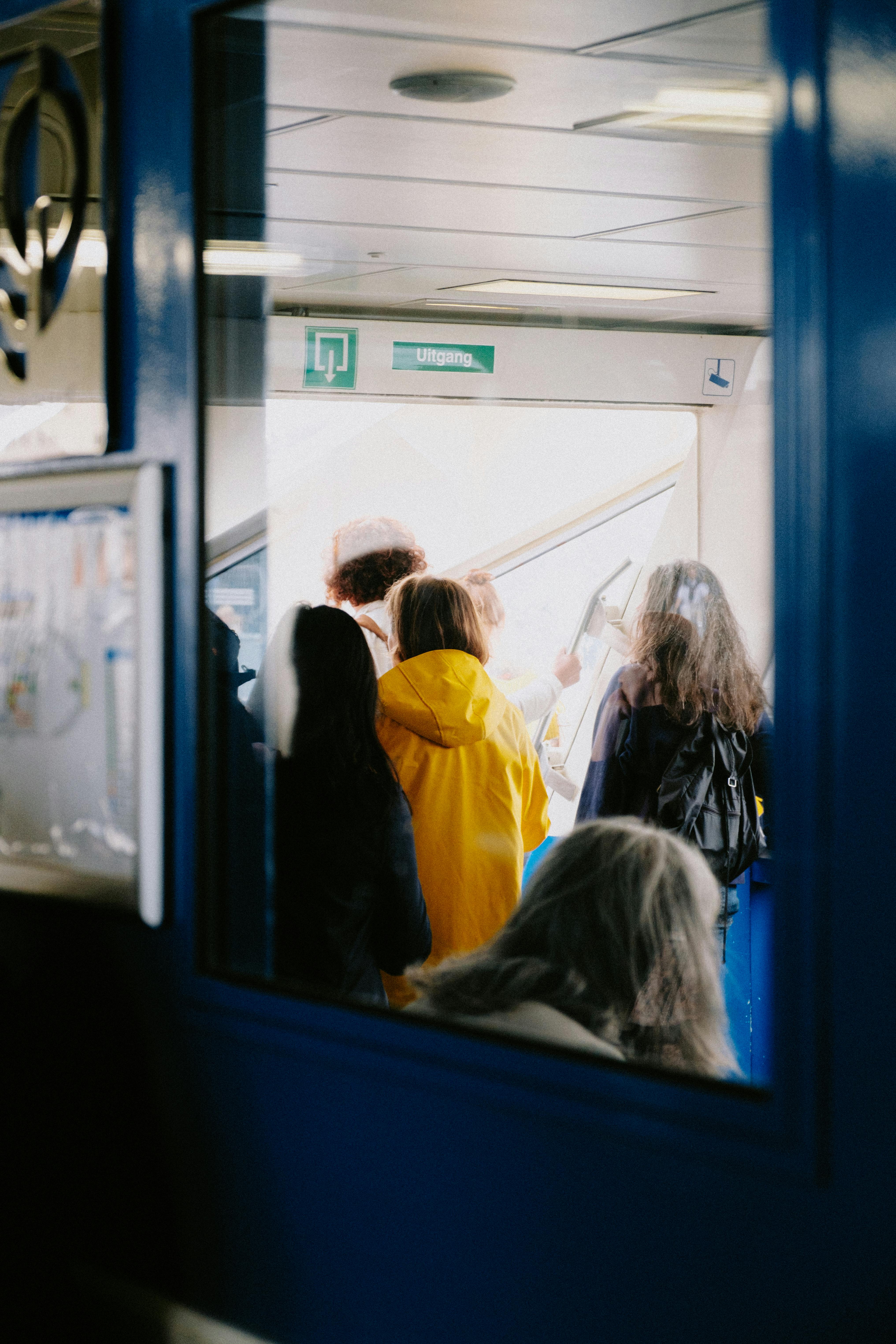 A group of people standing in a train station · Free Stock Photo