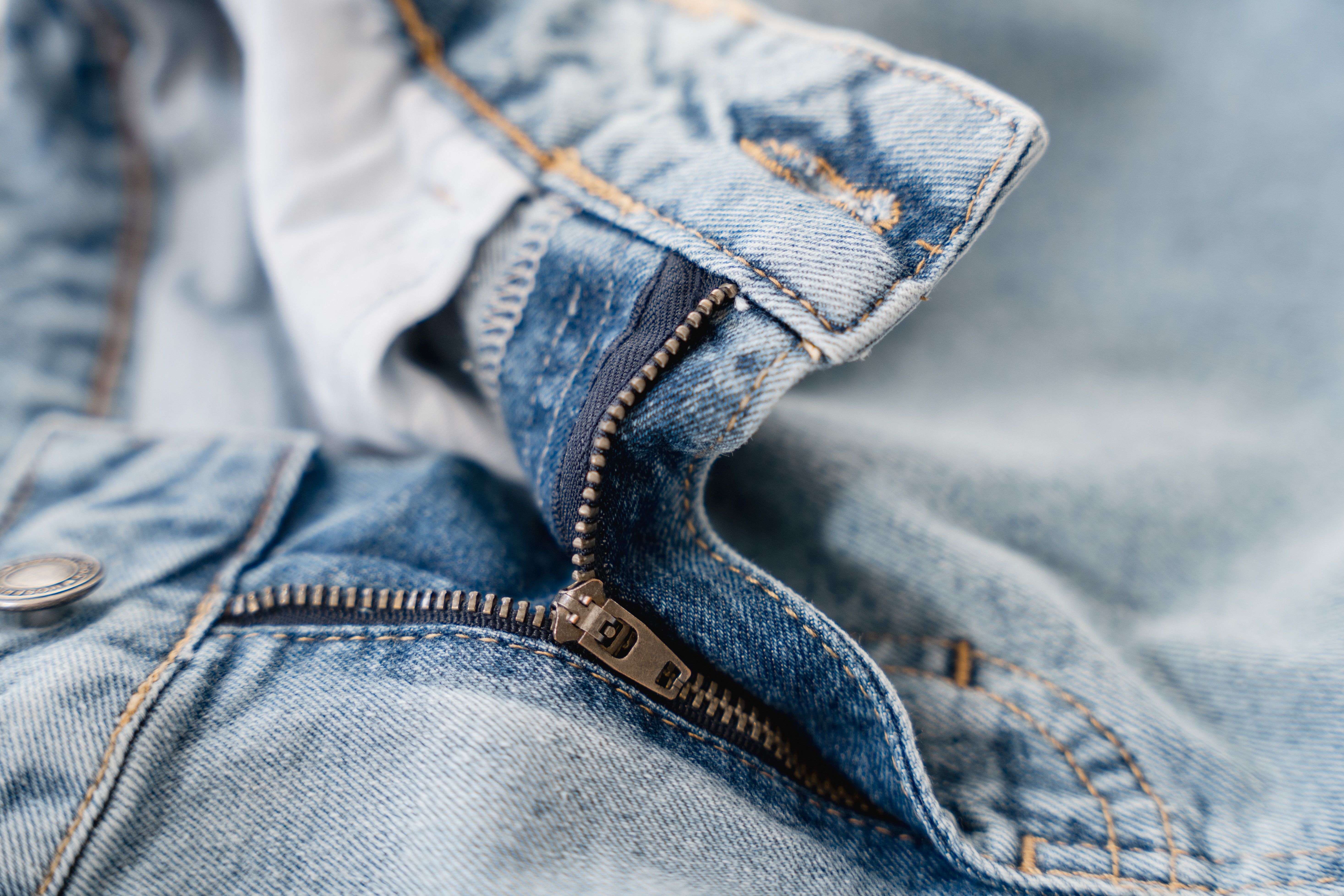 A close up of a zipper on a pair of jeans · Free Stock Photo