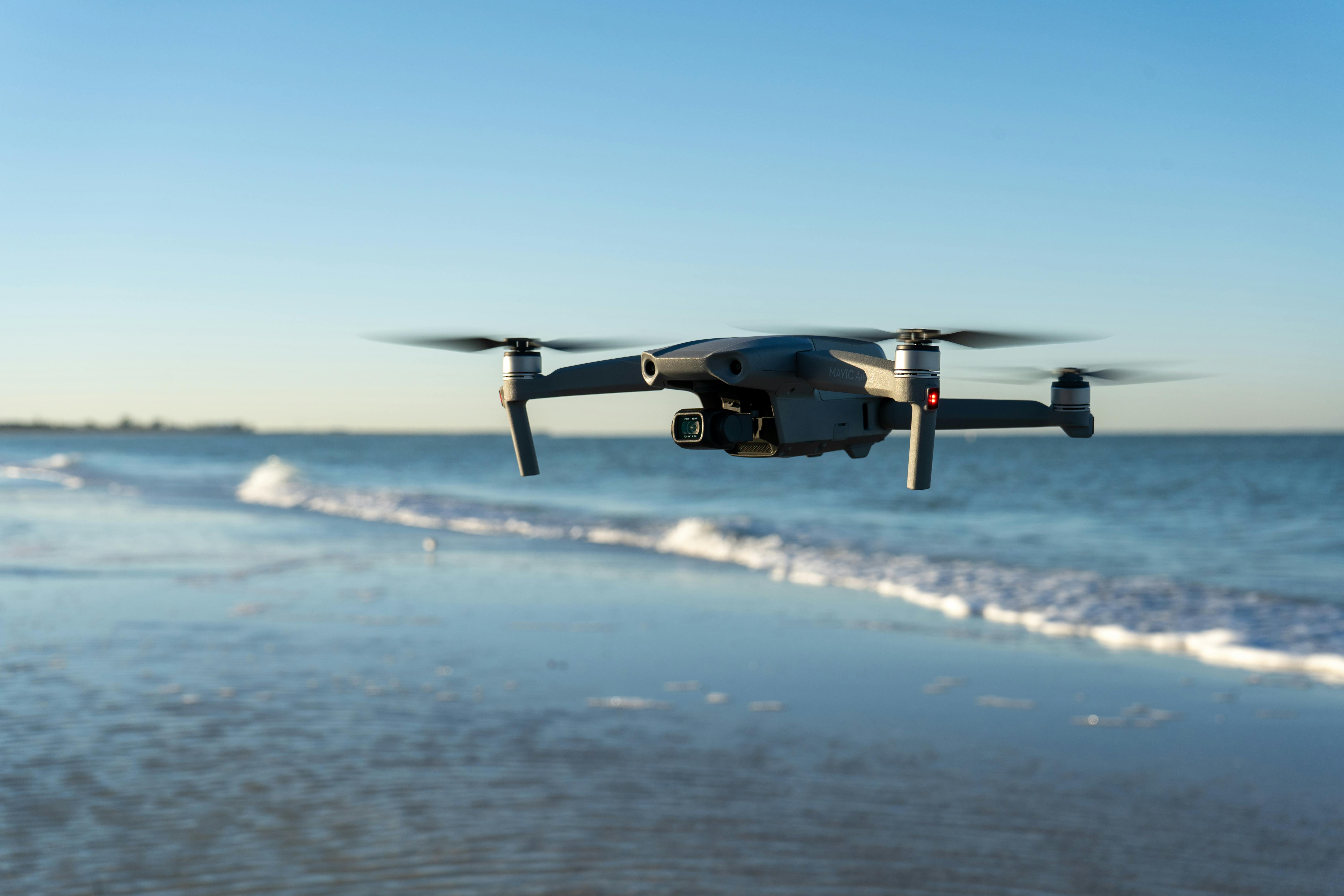 Close-up of a Drone over a Sea and Beach · Free Stock Photo