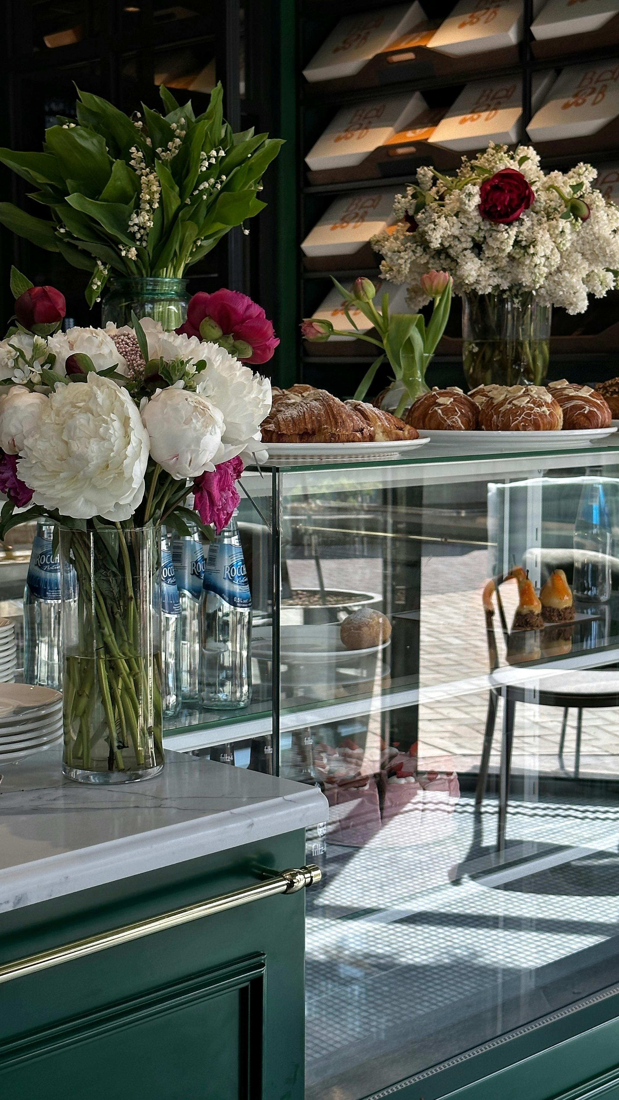 Flowers and Snacks in Bakery · Free Stock Photo