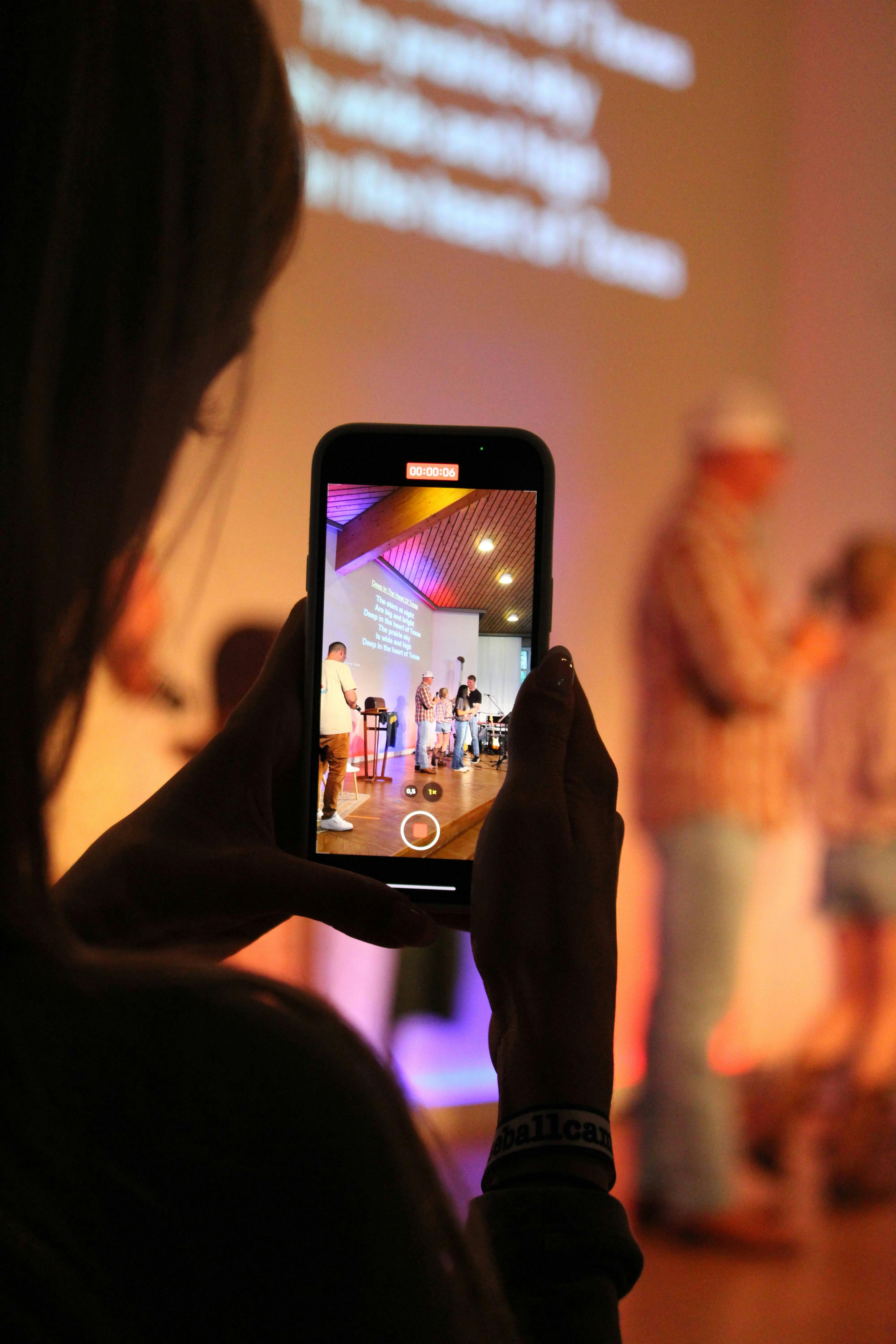 Close-up of a Woman Recording People on Stage with a Smartphone · Free ...