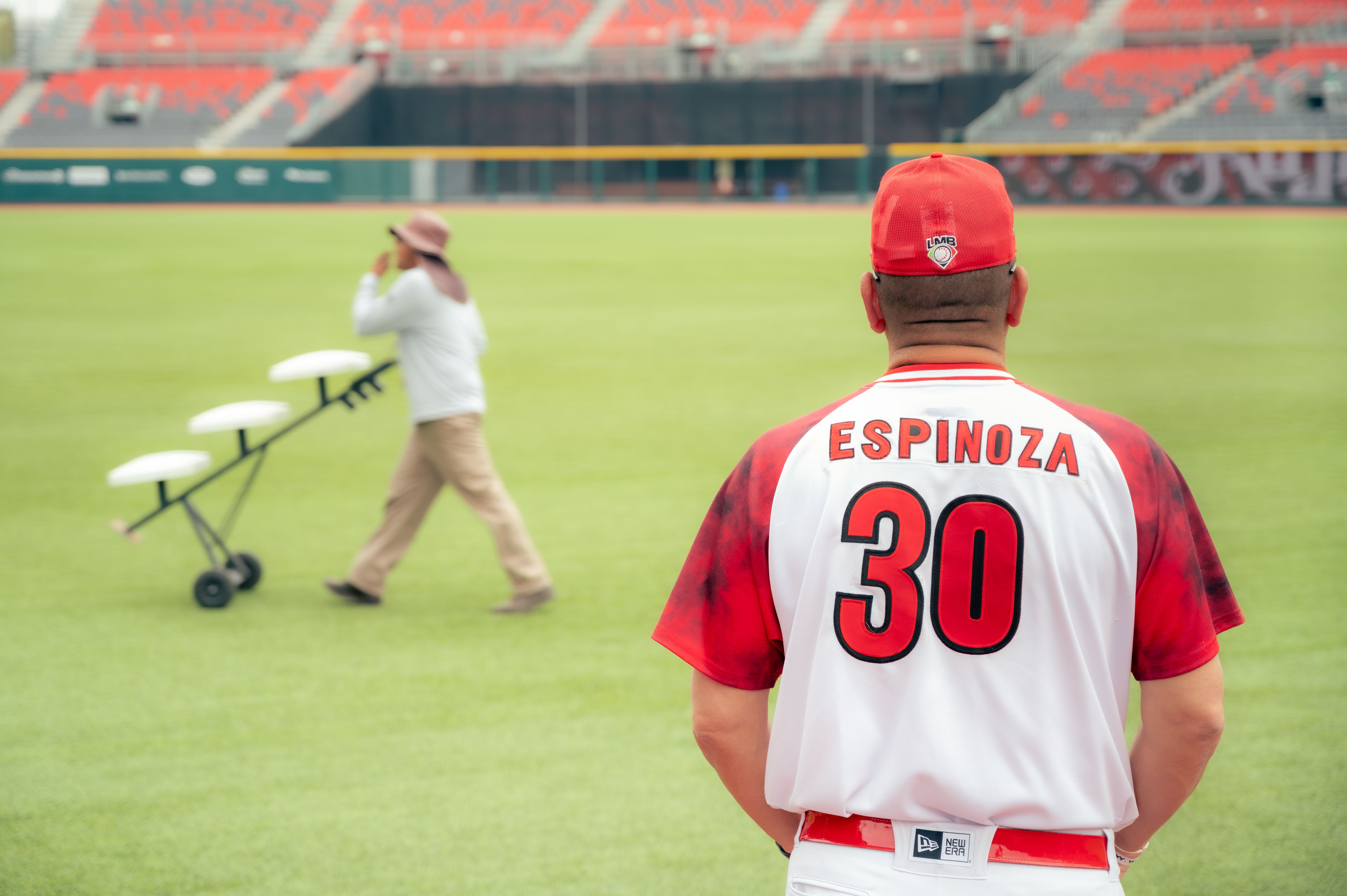 A man in a baseball uniform stands on the field · Free Stock Photo