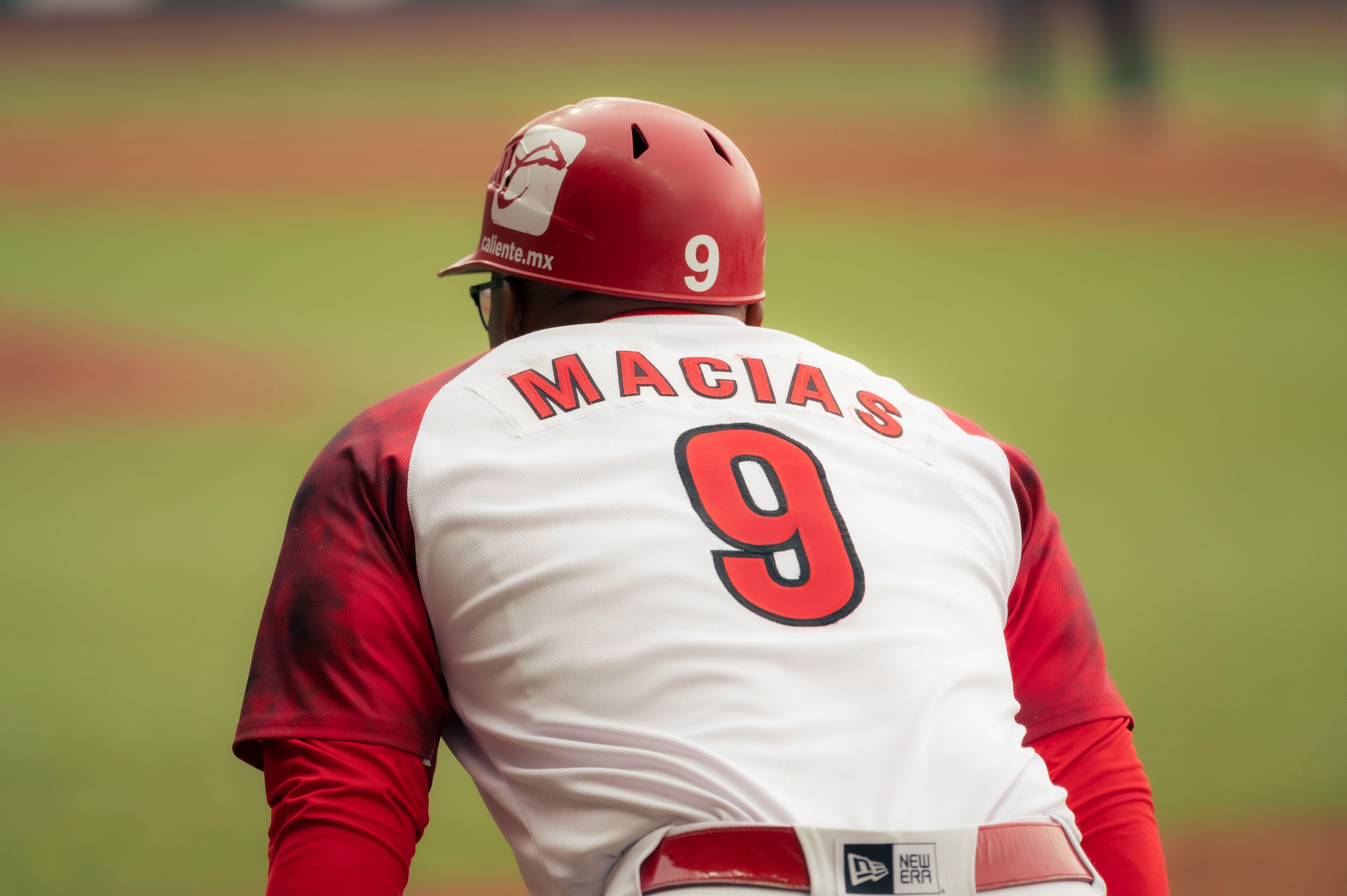 A baseball player is wearing a red and white uniform · Free Stock Photo