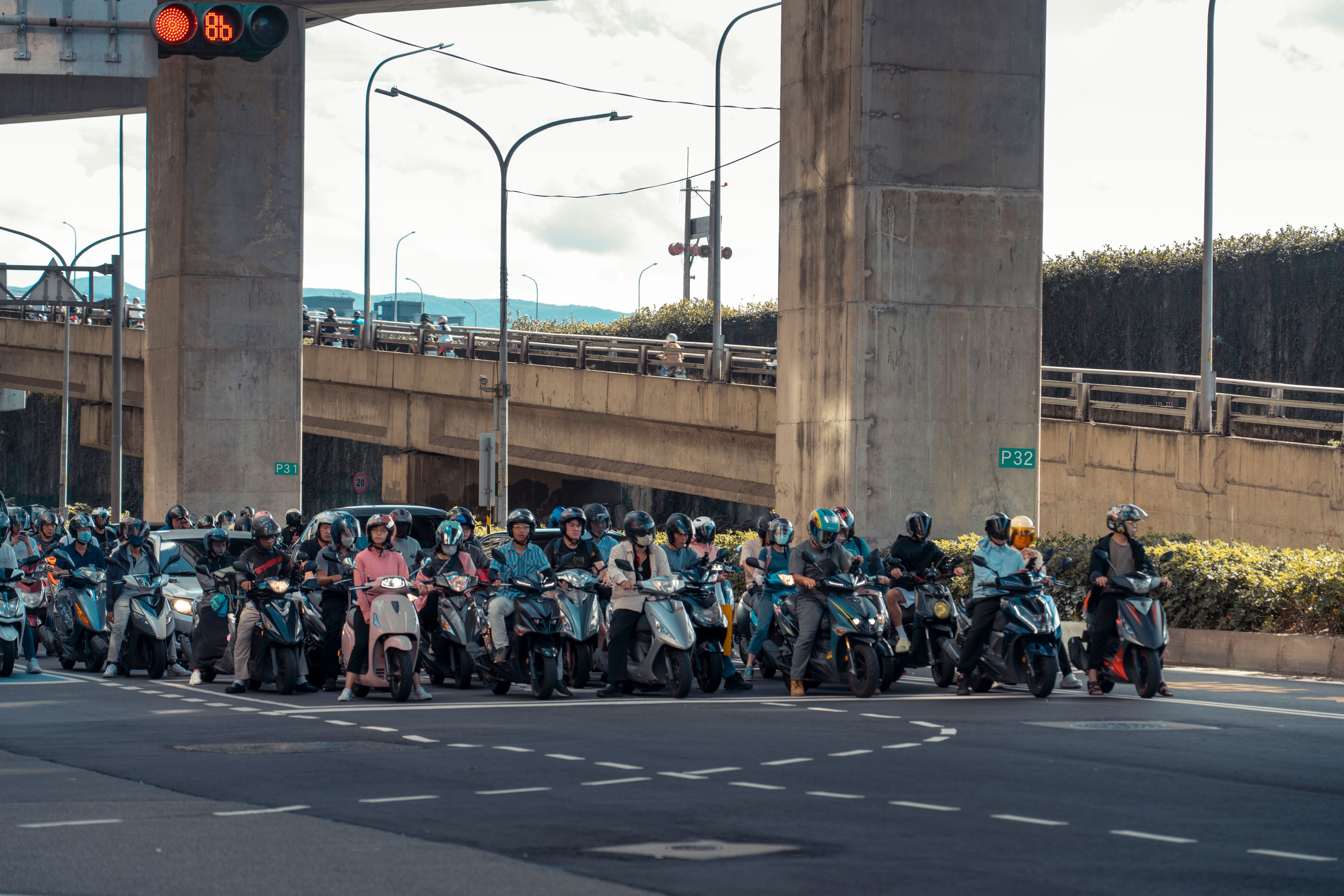 A group of people on motorcycles are waiting for a light · Free Stock Photo
