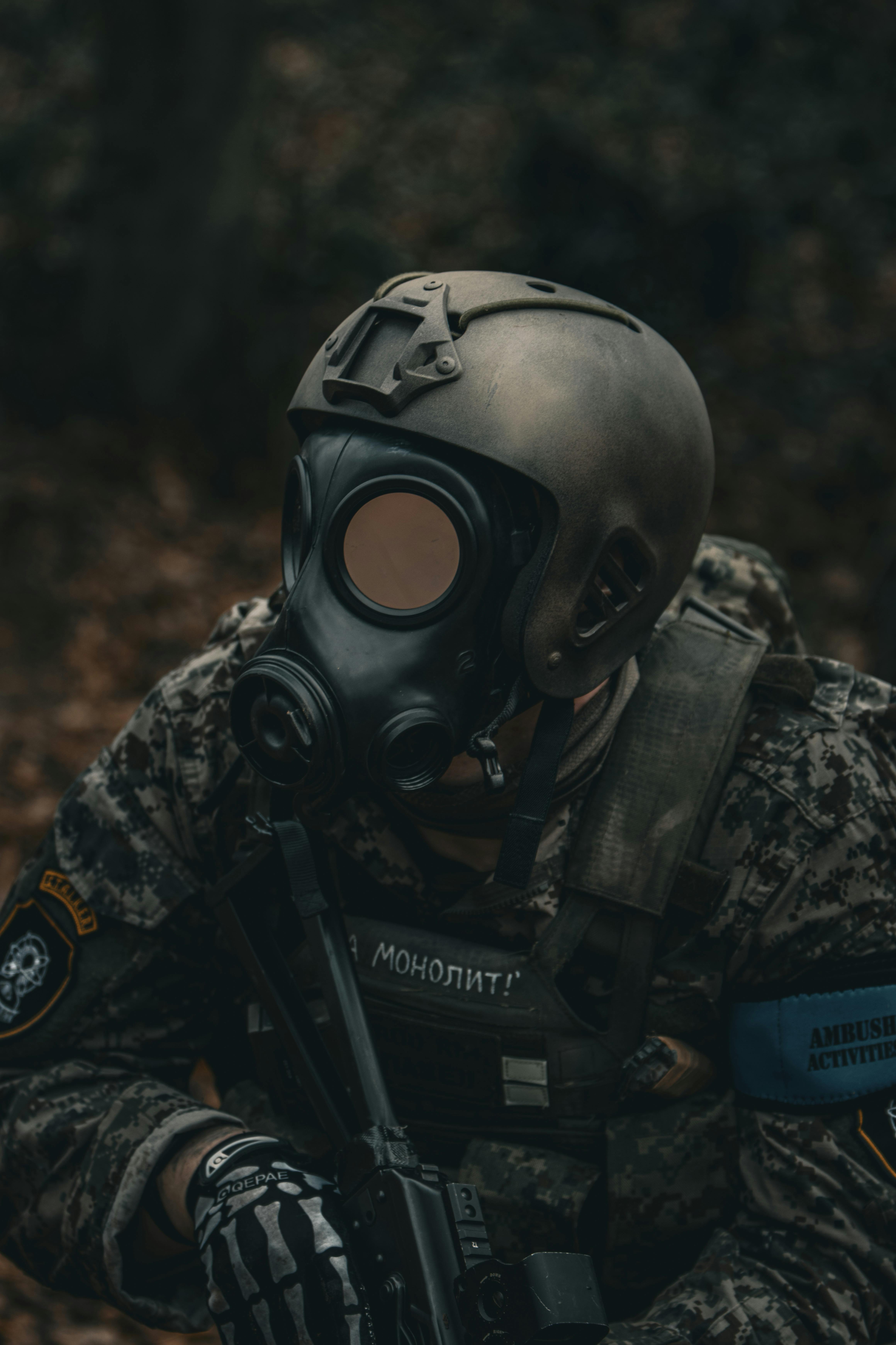 A soldier wearing a gas mask and holding a rifle · Free Stock Photo