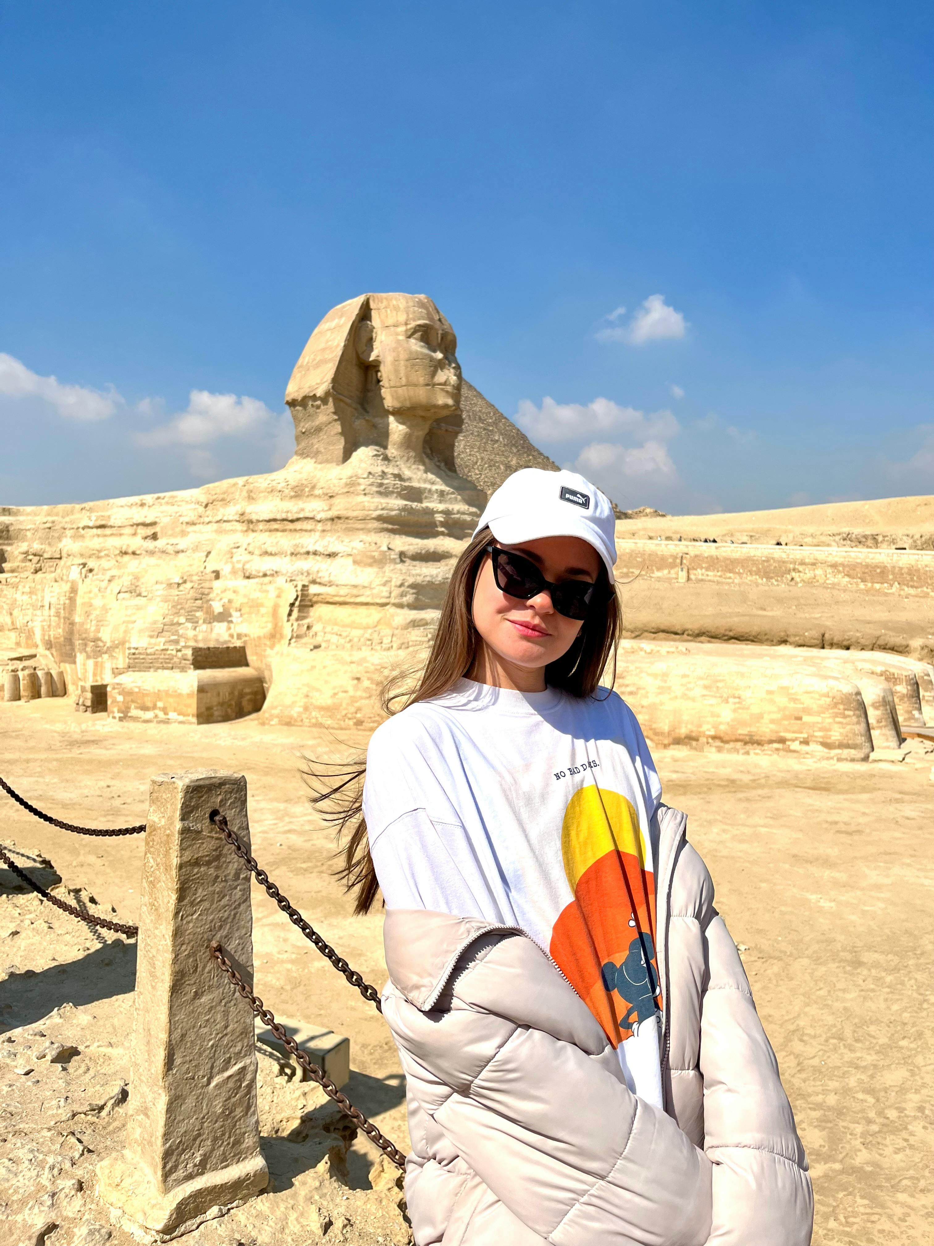 Portrait of Woman with Sphinx behind · Free Stock Photo