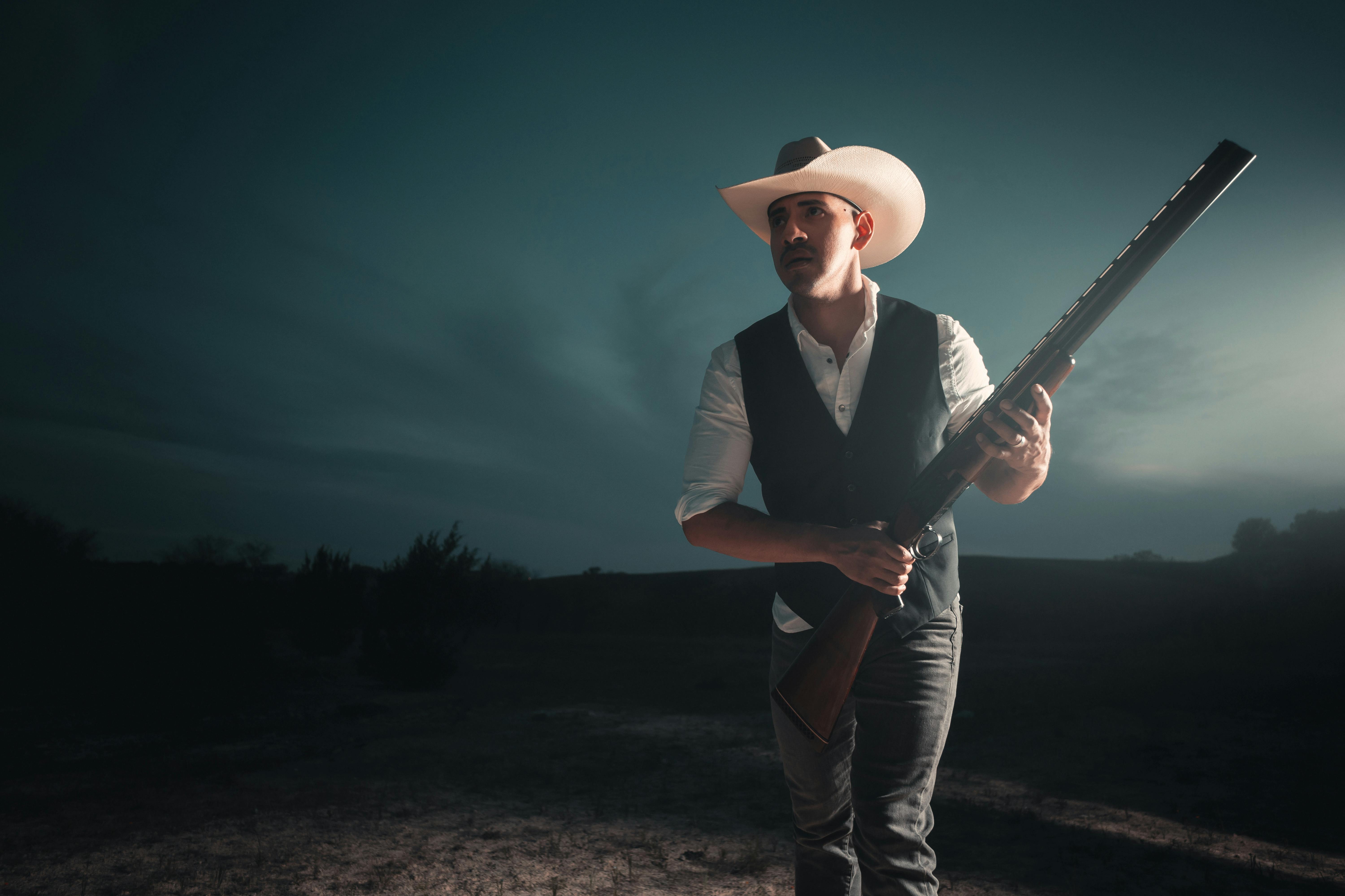 Cowboy with Shotgun at Night · Free Stock Photo