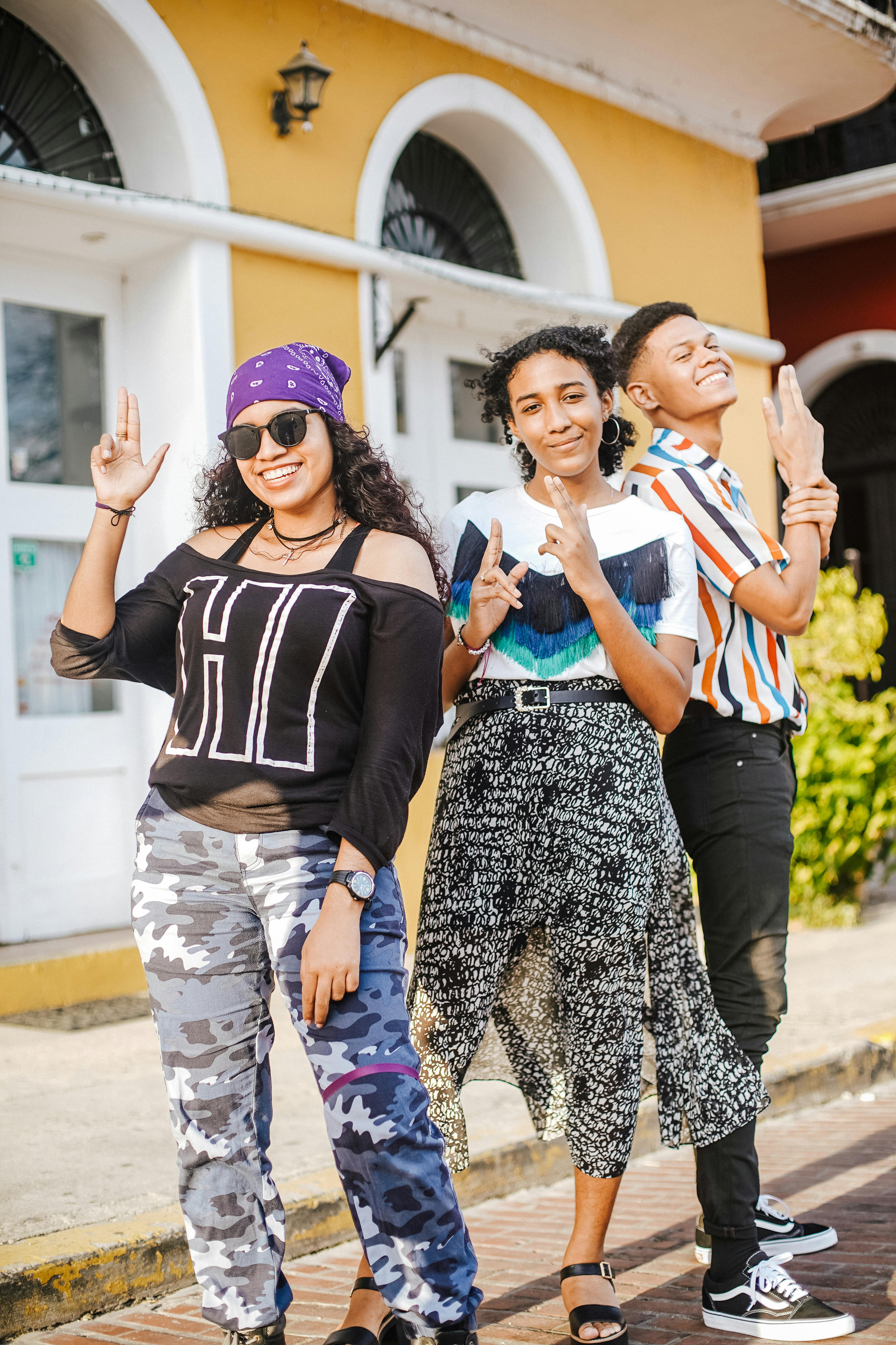 Three People Posing Outdoors · Free Stock Photo