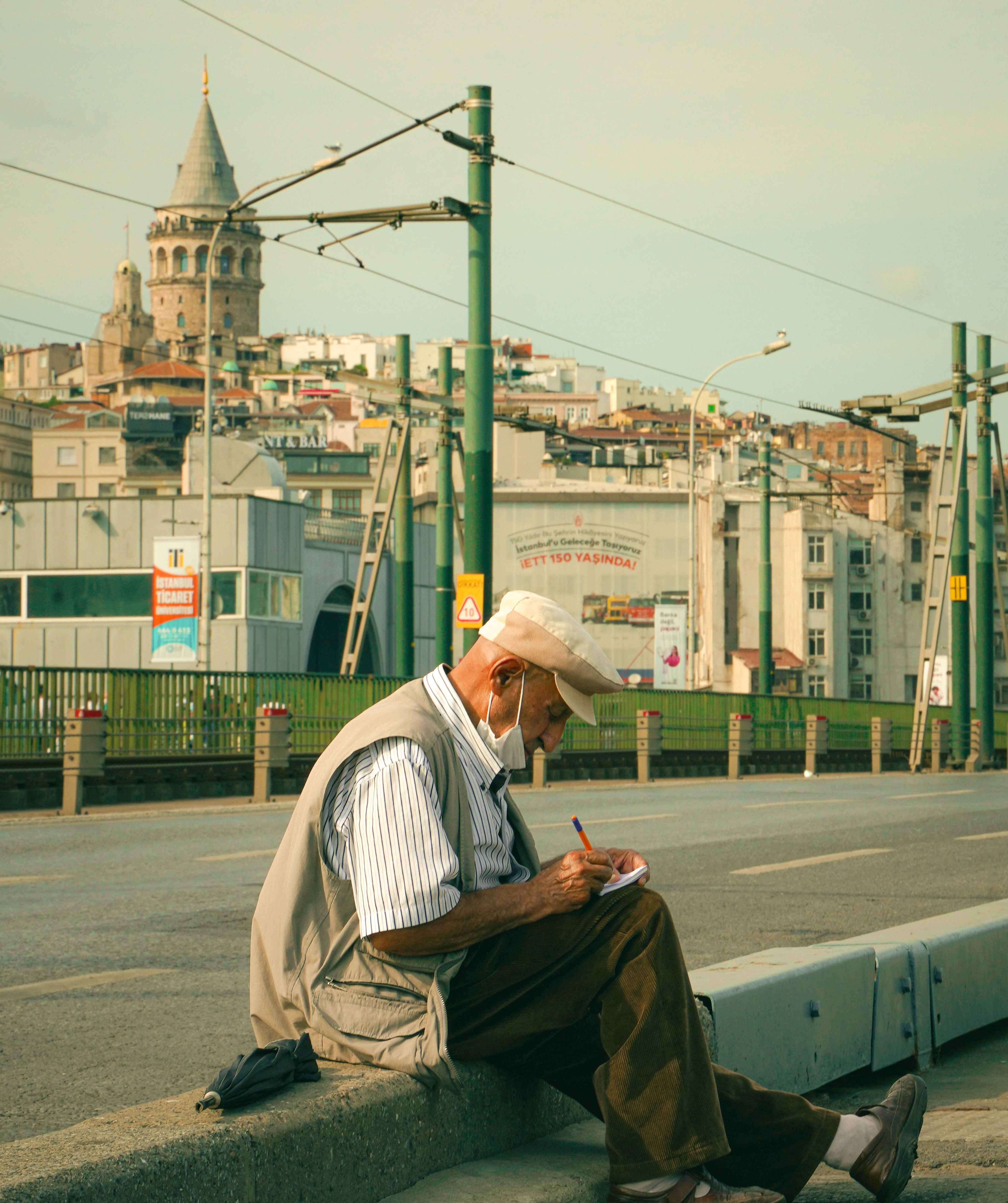 Man Sitting on Curb in Istanbul · Free Stock Photo