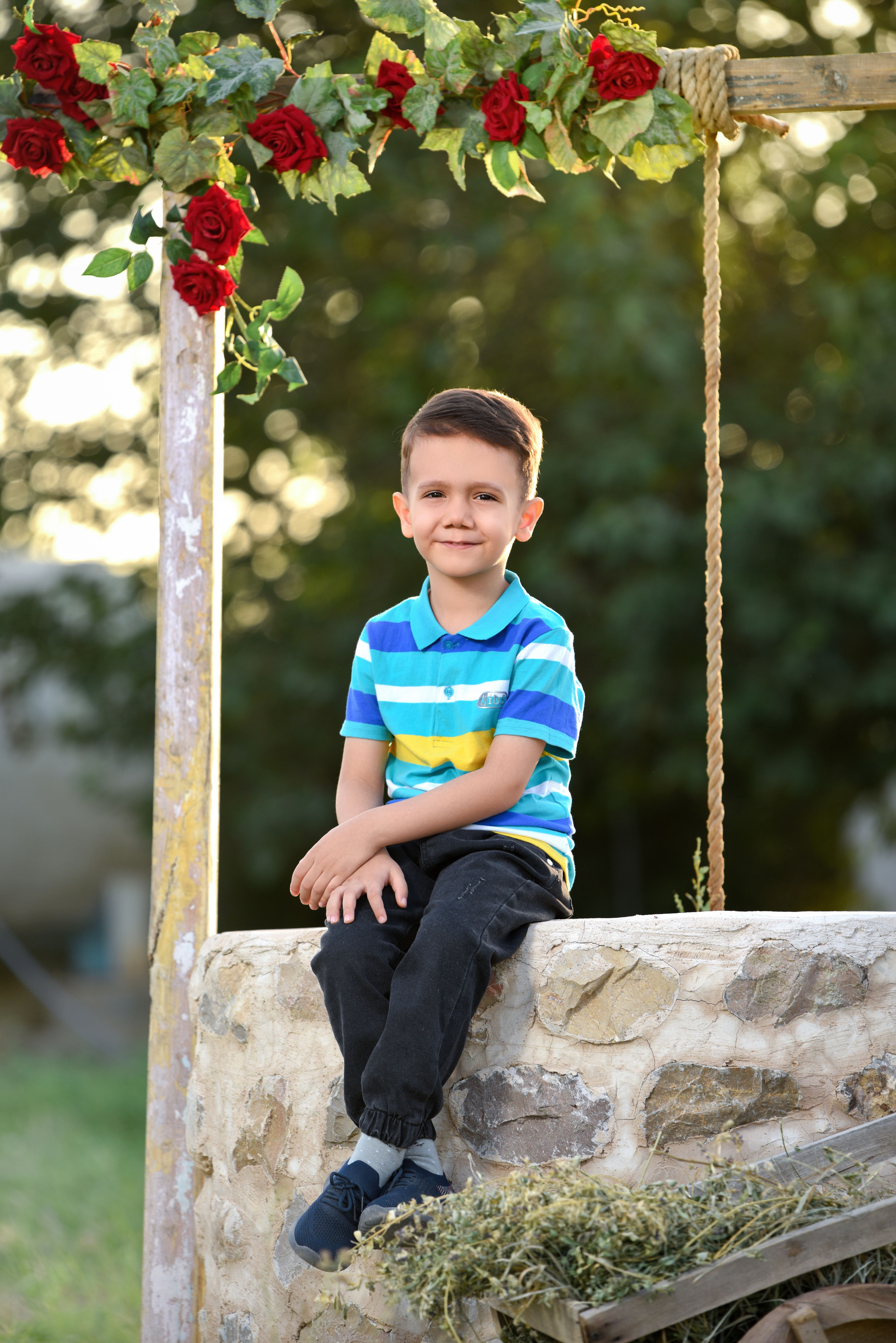 Boy Sitting on Stone Well · Free Stock Photo