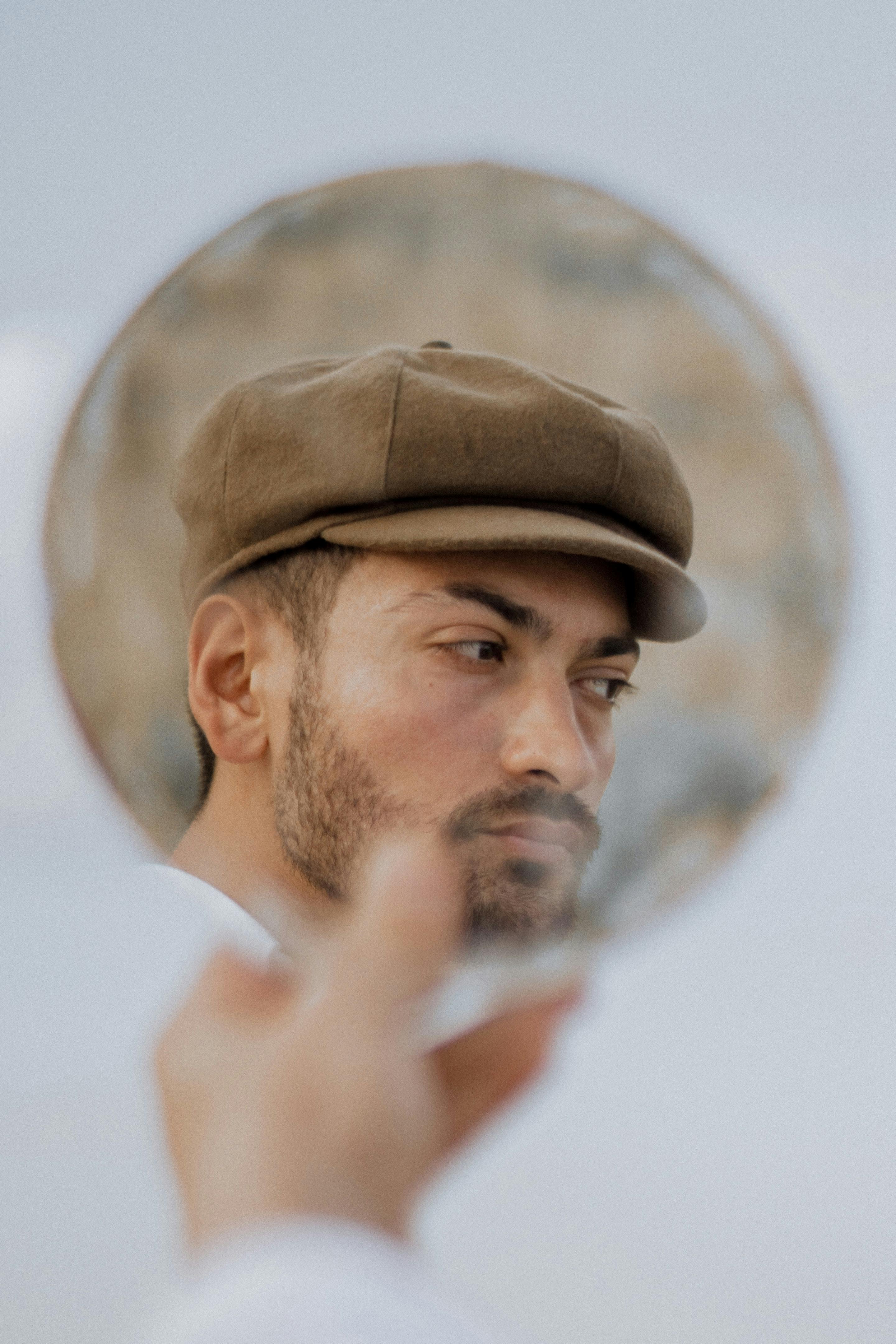 Handsome Man Reflecting in a Round Mirror · Free Stock Photo