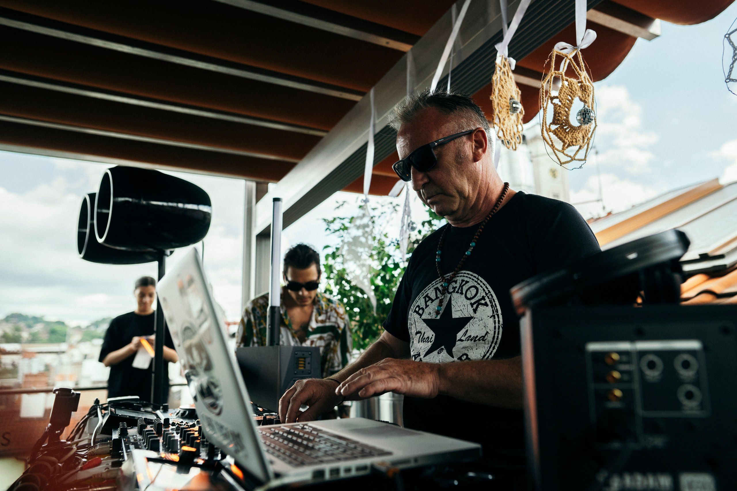 DJ Using a Computer and a Sound Mixer · Free Stock Photo
