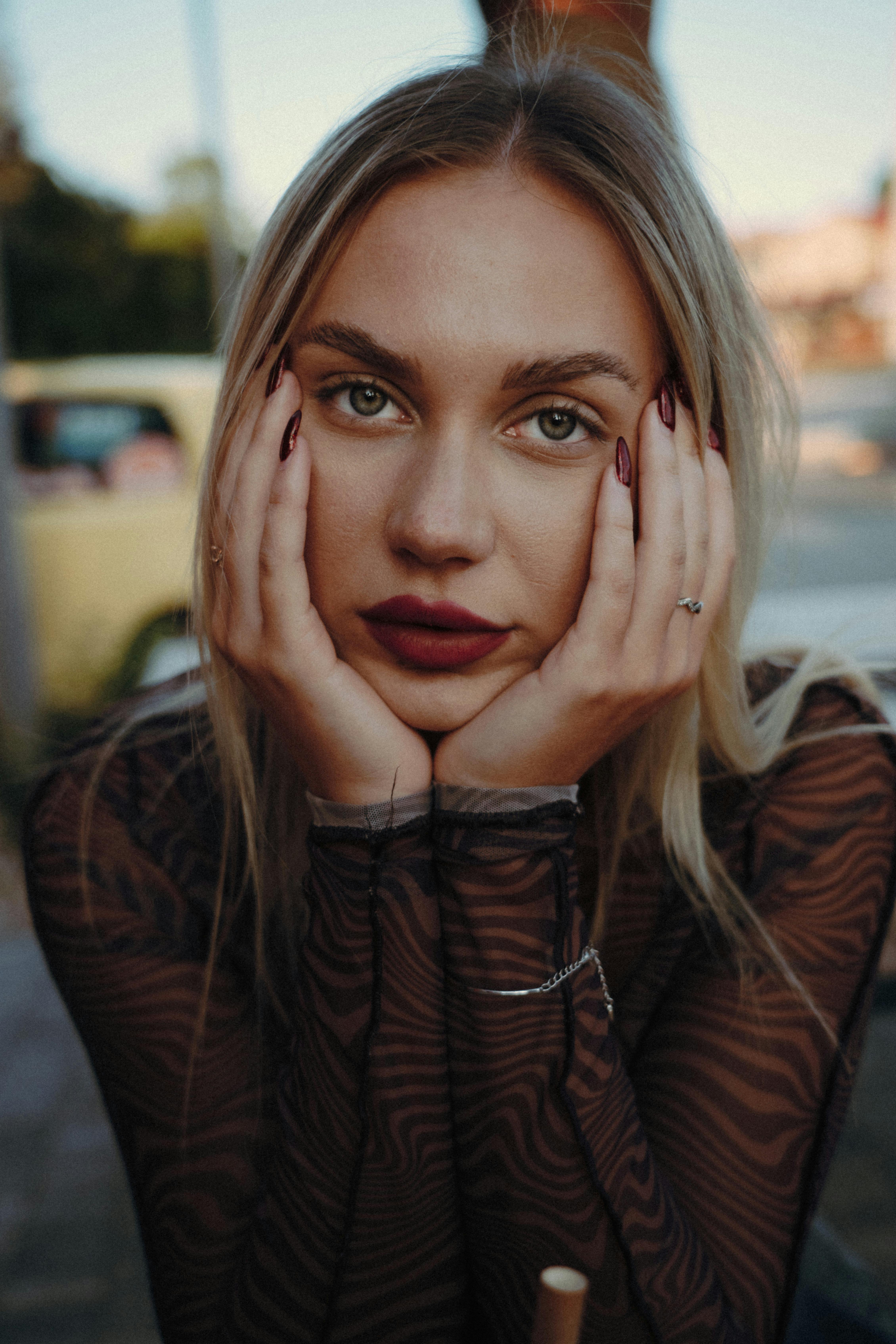 Portrait of a Woman Touching her Face · Free Stock Photo