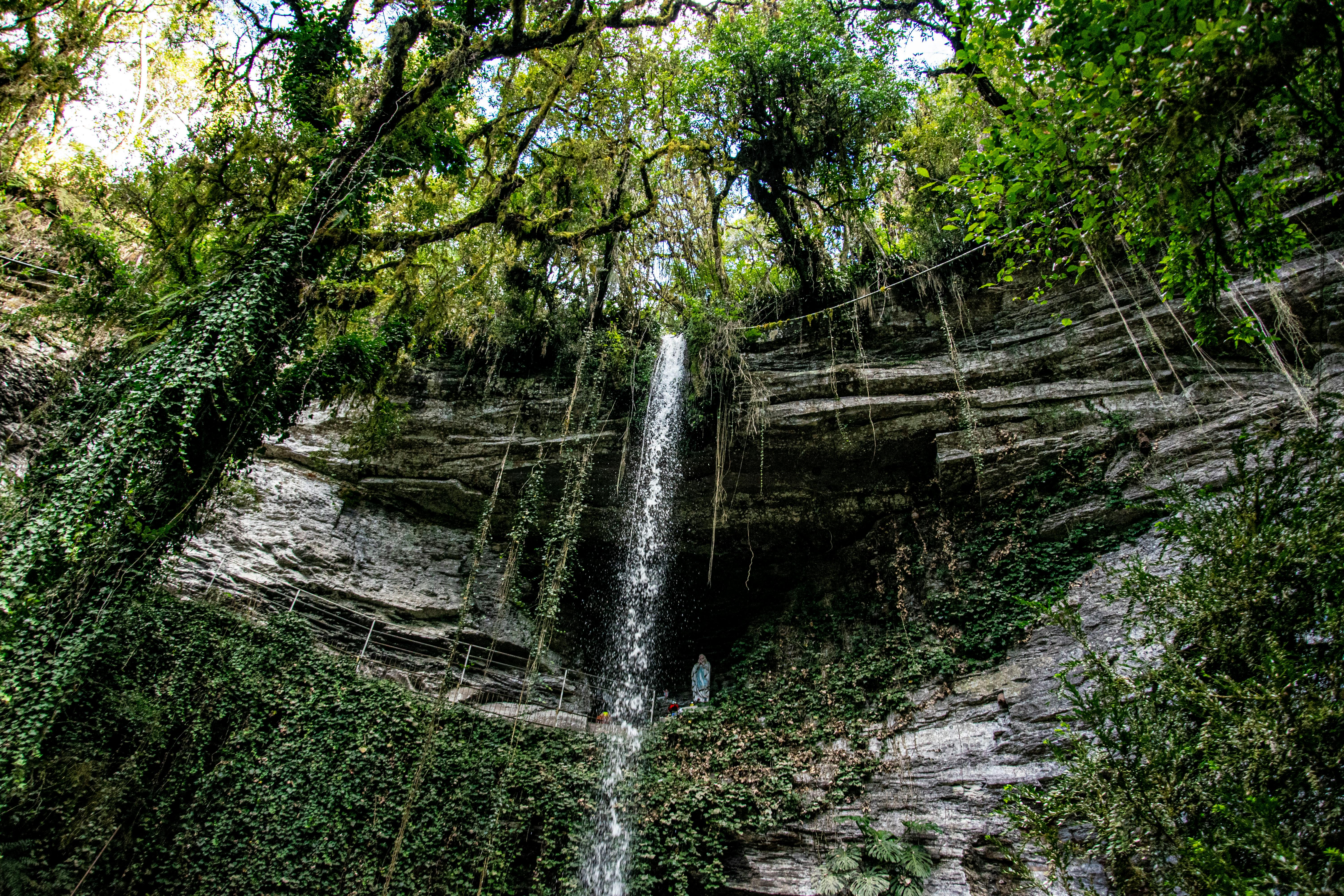 Waterfall over Cave in Forest · Free Stock Photo