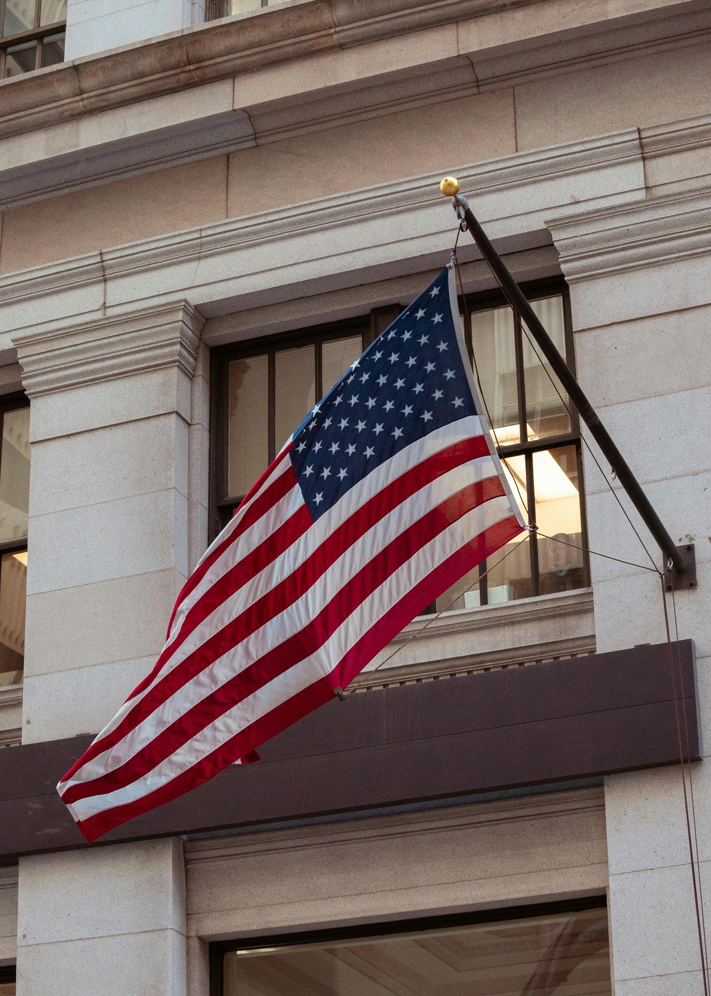 USA Flag Hoisted on an Administrative Building · Free Stock Photo