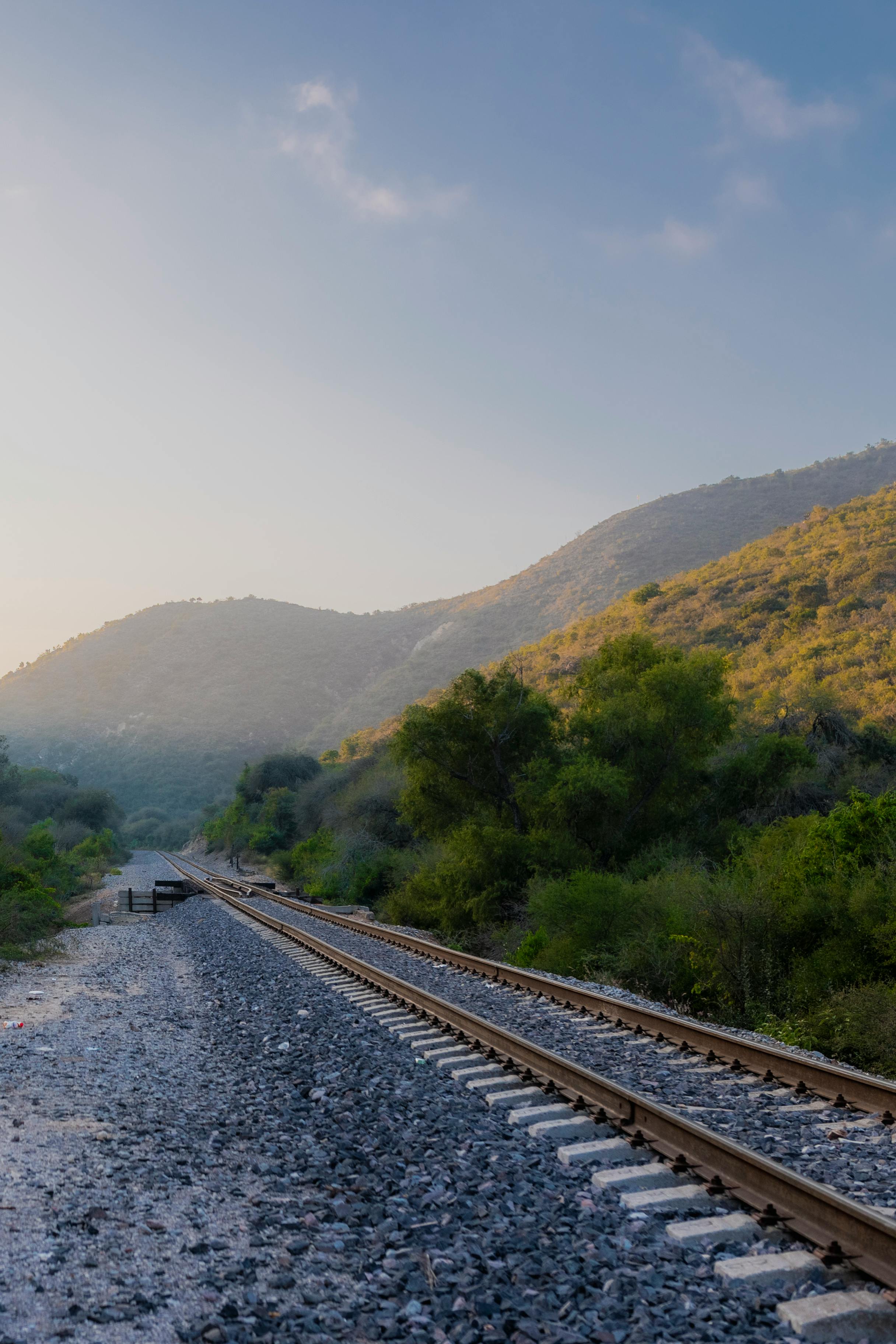 Railway Track near Hills · Free Stock Photo