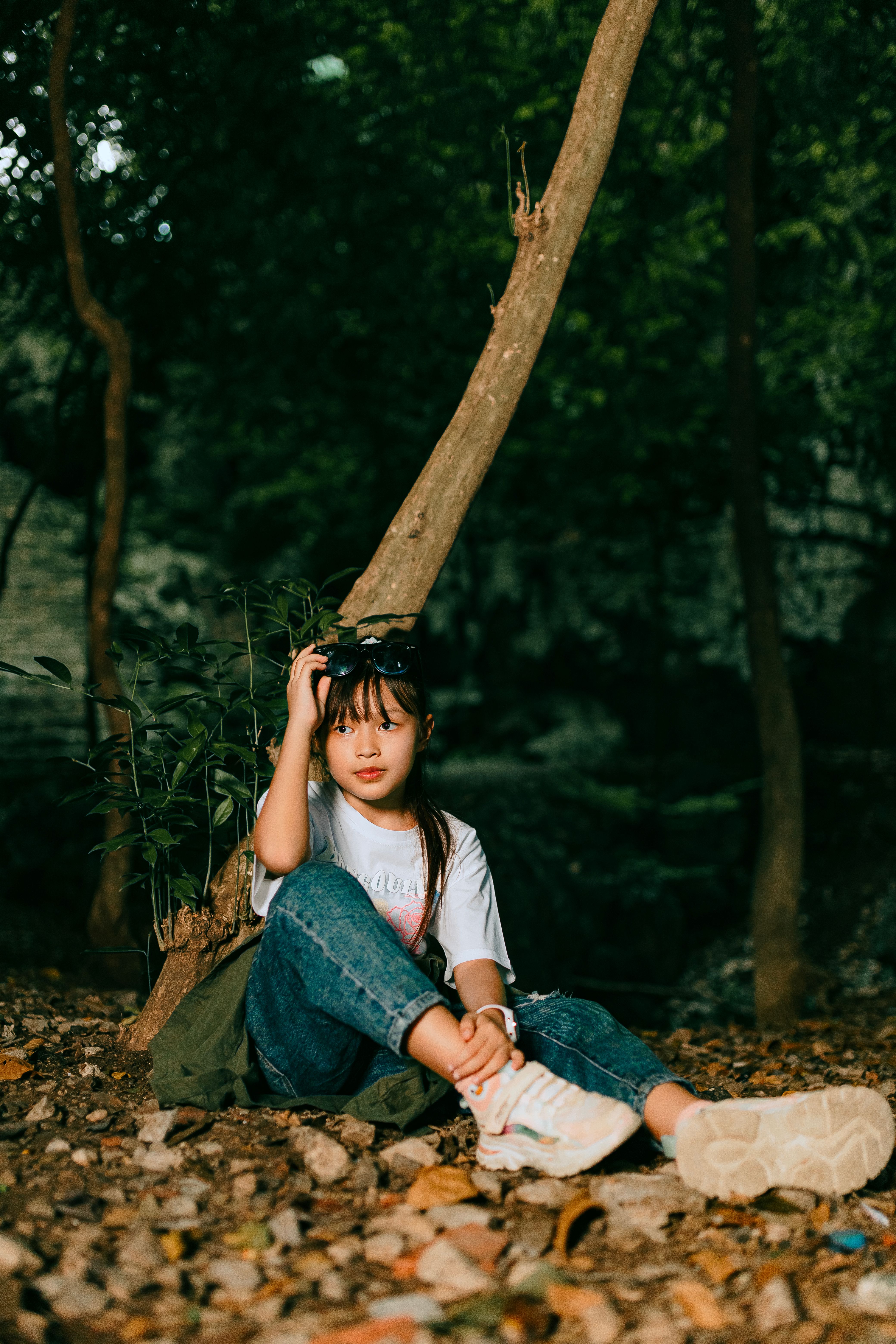Young Girl Sitting under a Tree in the Forest · Free Stock Photo