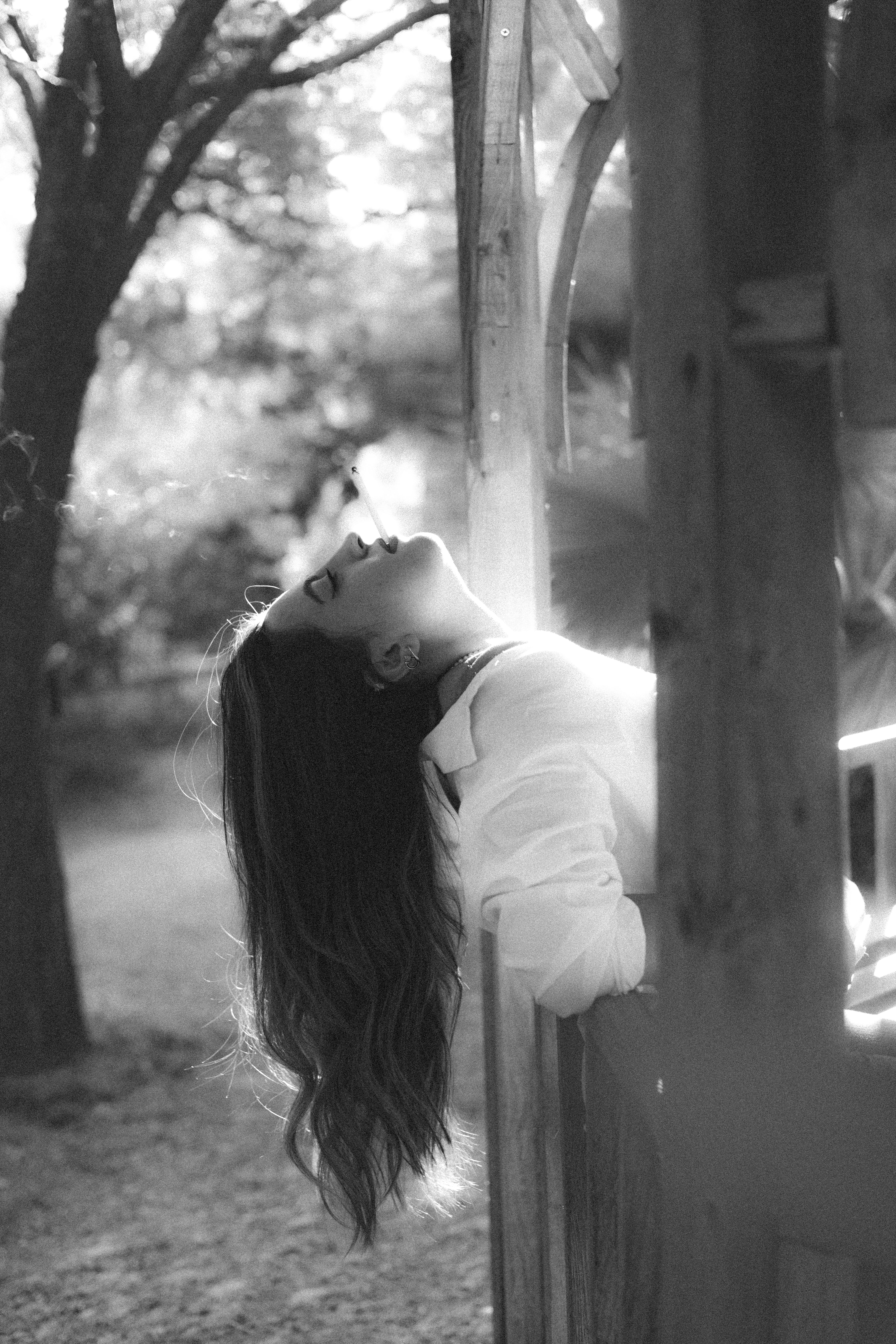 Woman Sitting with her Head Tilted Back and Smoking a Cigarette · Free ...