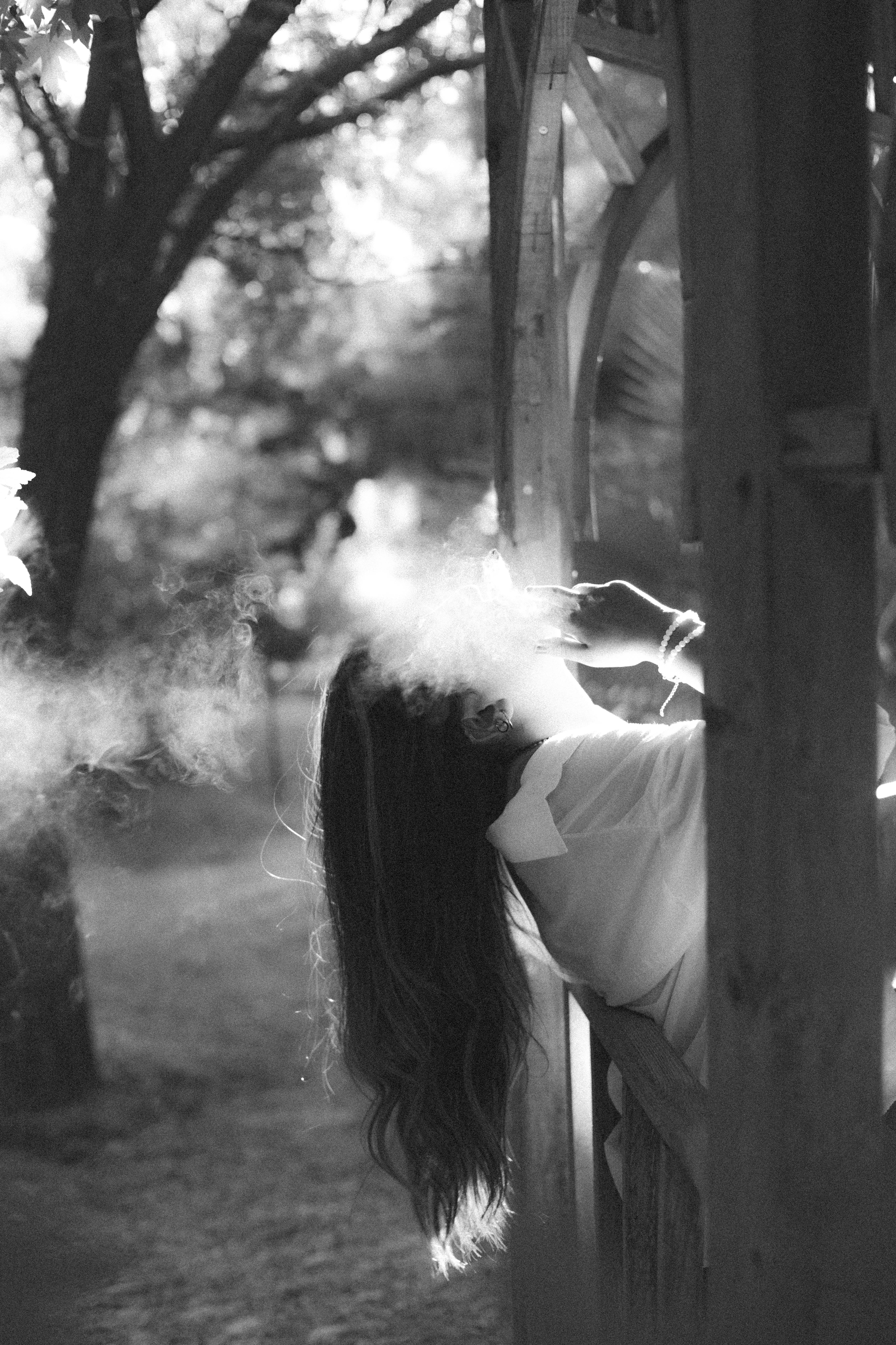 Woman Leaning on Railing and Smoking · Free Stock Photo