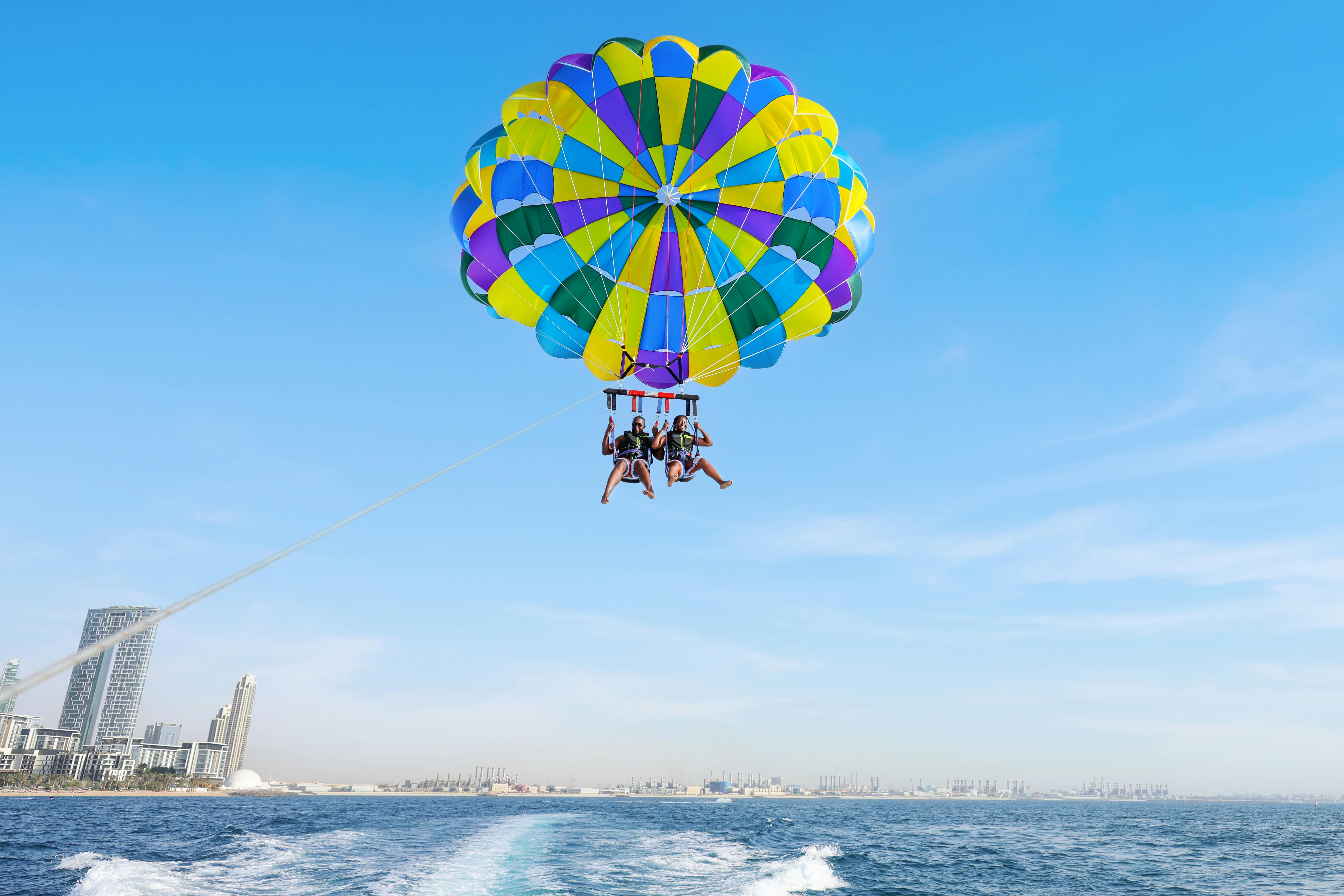 People Parachuting over Sea Shore · Free Stock Photo