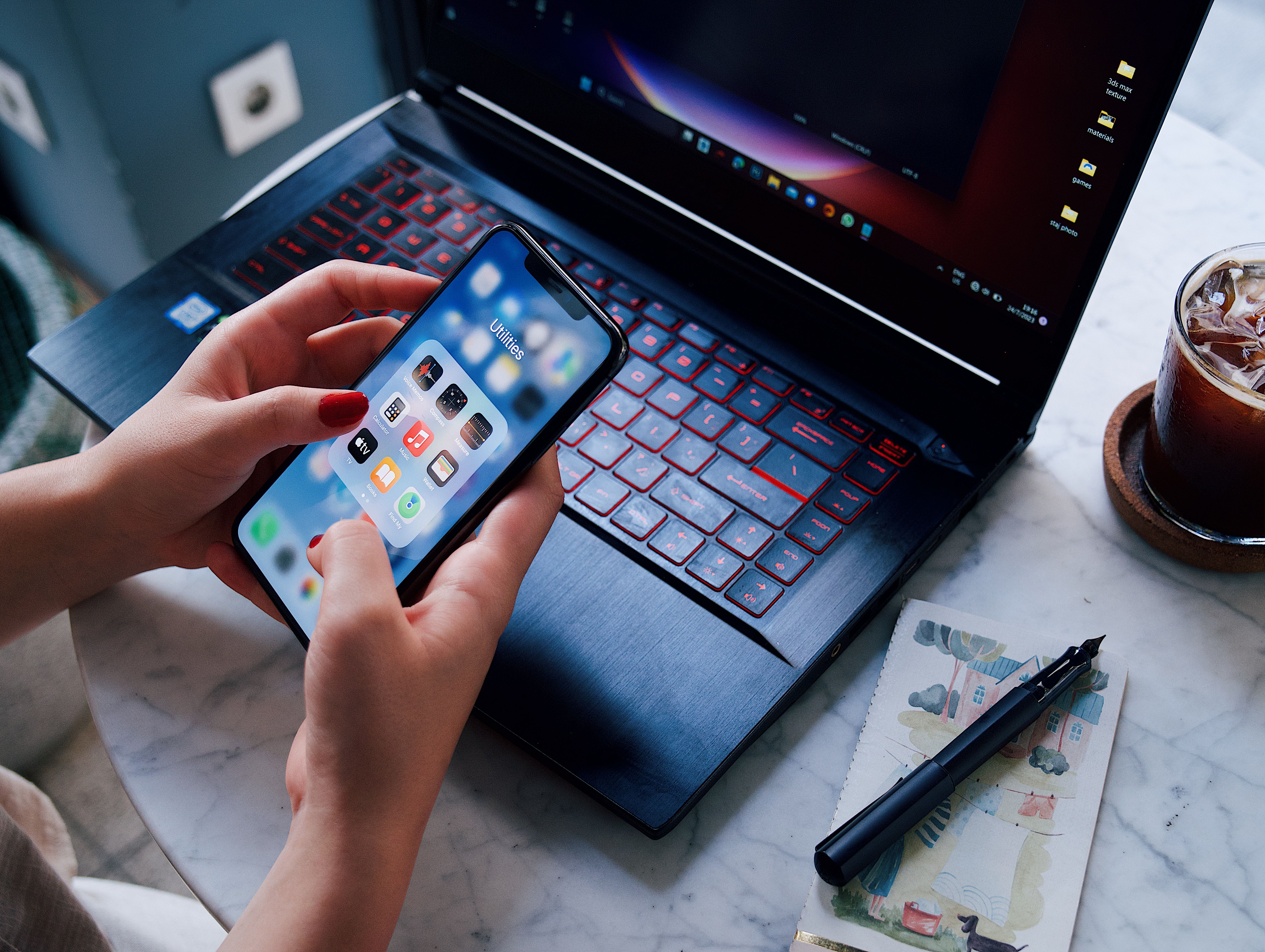 Woman Hands with Cellphone over Laptop · Free Stock Photo
