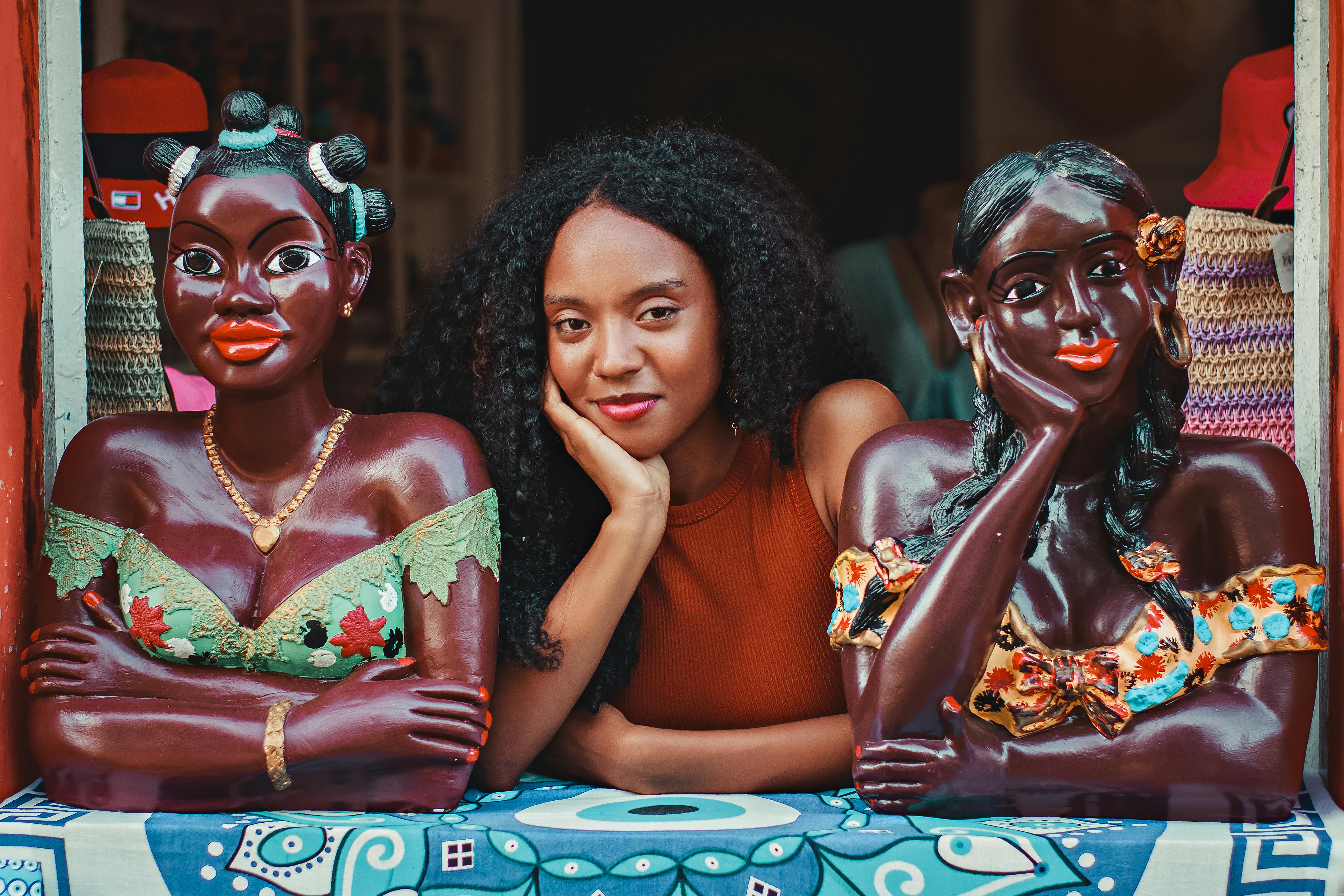 Woman between Two Figures · Free Stock Photo