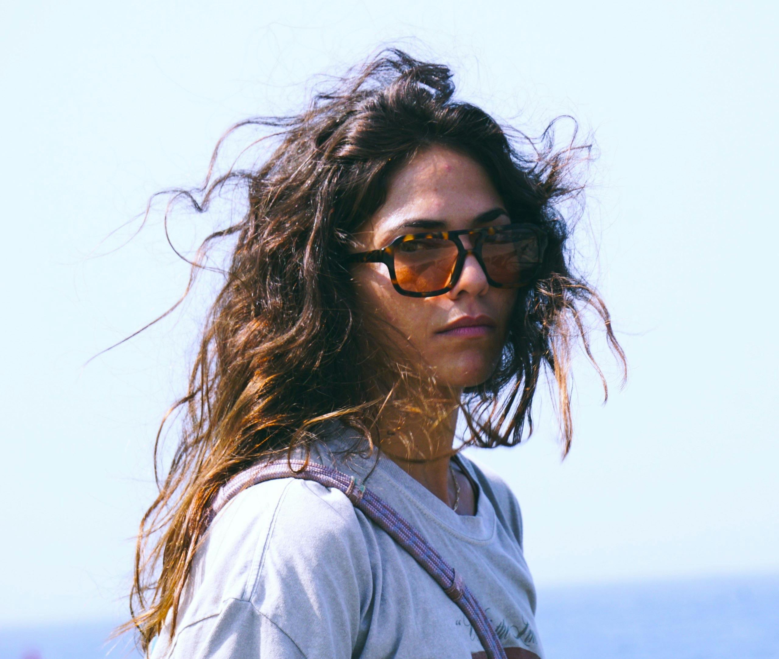 Young Redhead Standing Outdoors with Her Hair Messed by the Wind · Free ...