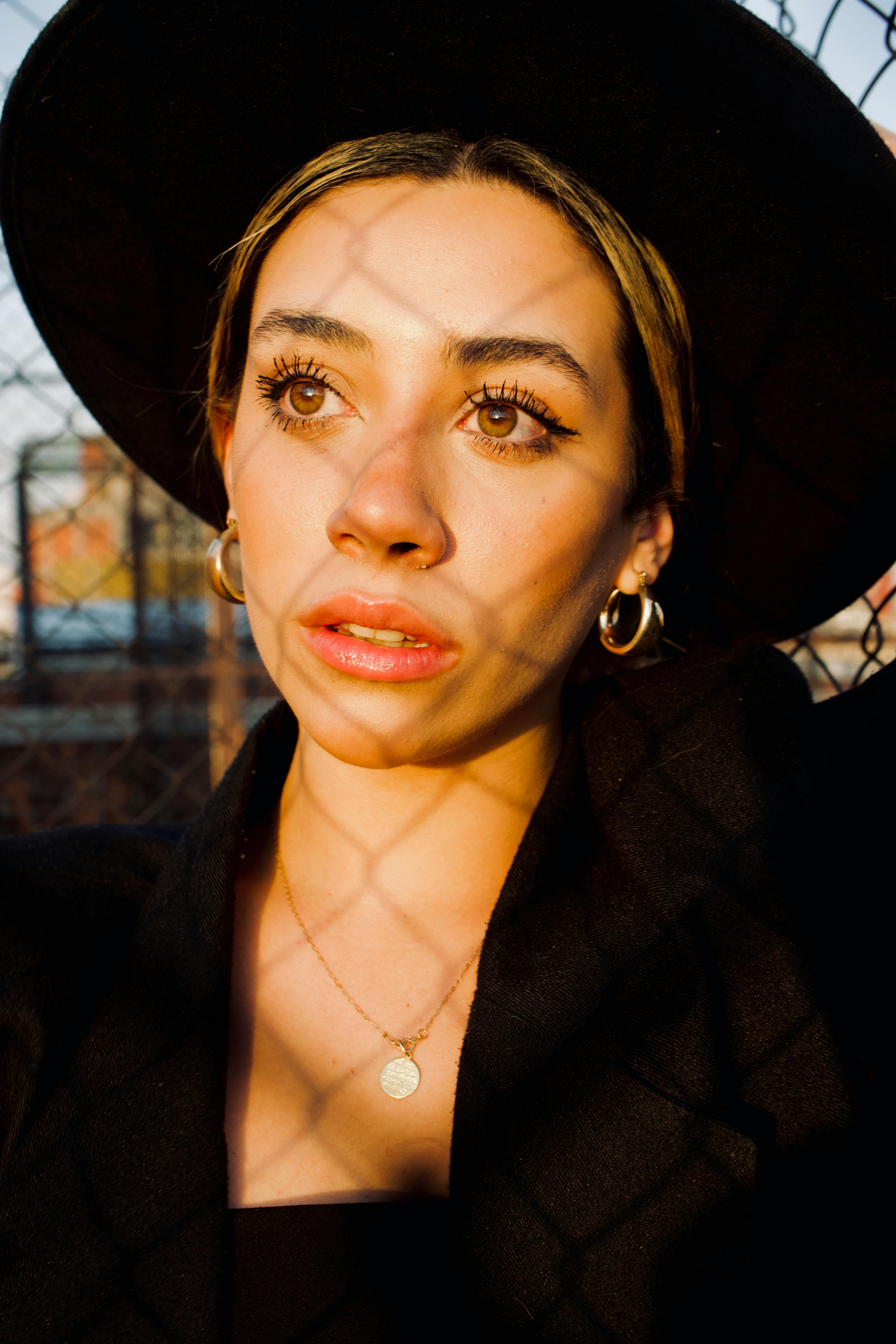Sunlit Face of Woman in Hat · Free Stock Photo